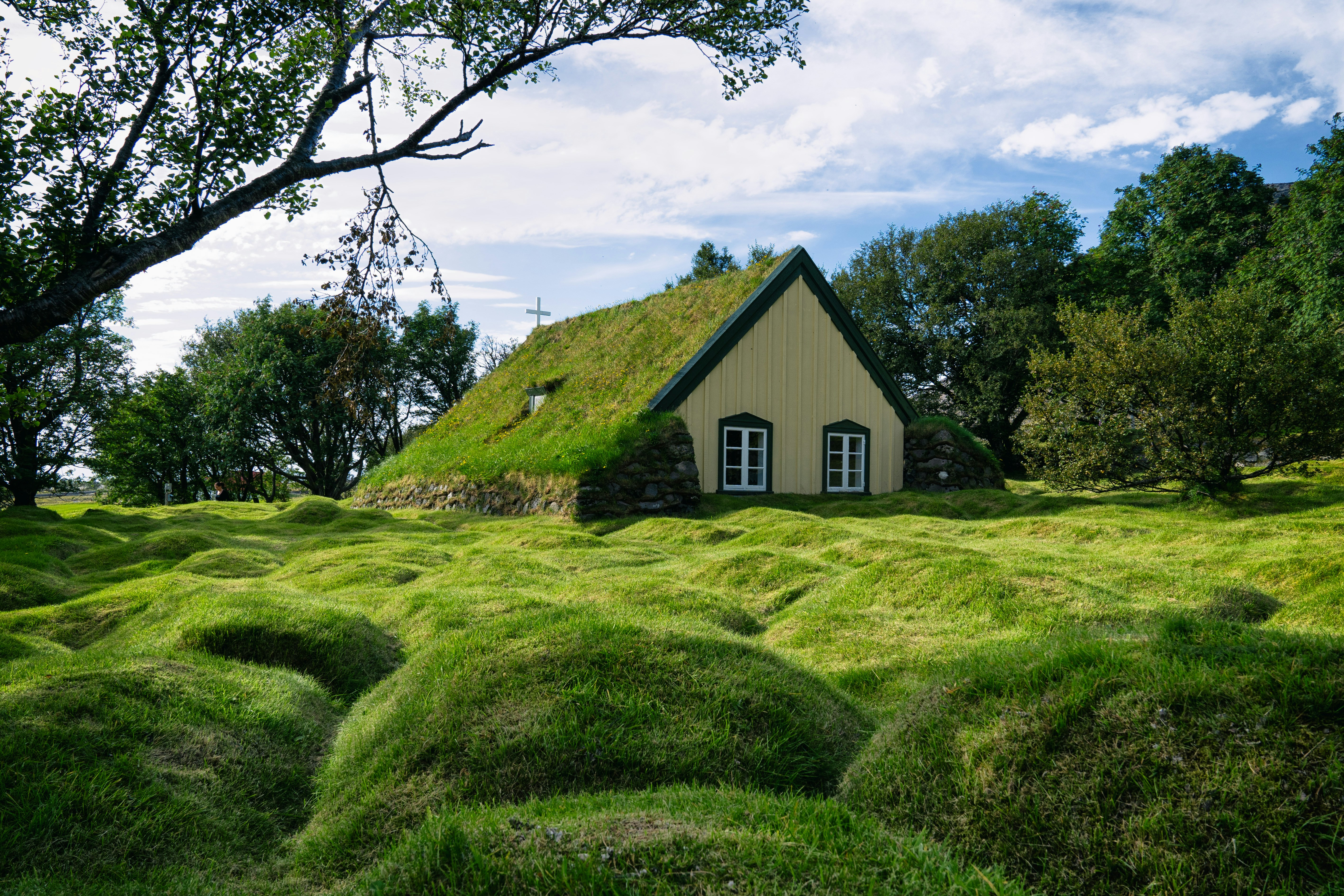 A house with a green roof surrounded by grass photo – Free Grass Image ...