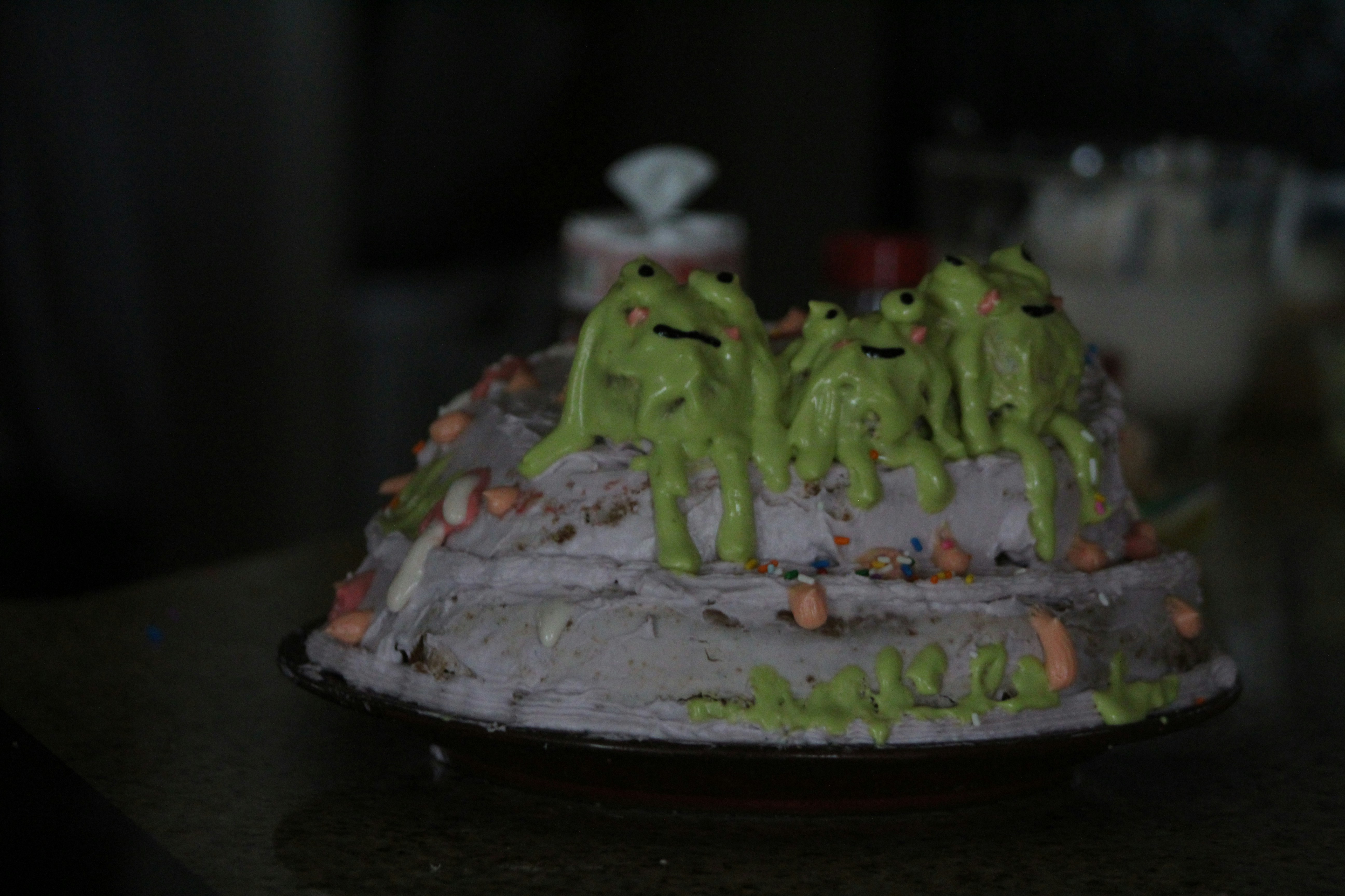 Frogs on Frosting: A Moonlit Cake Scene with Green Guests