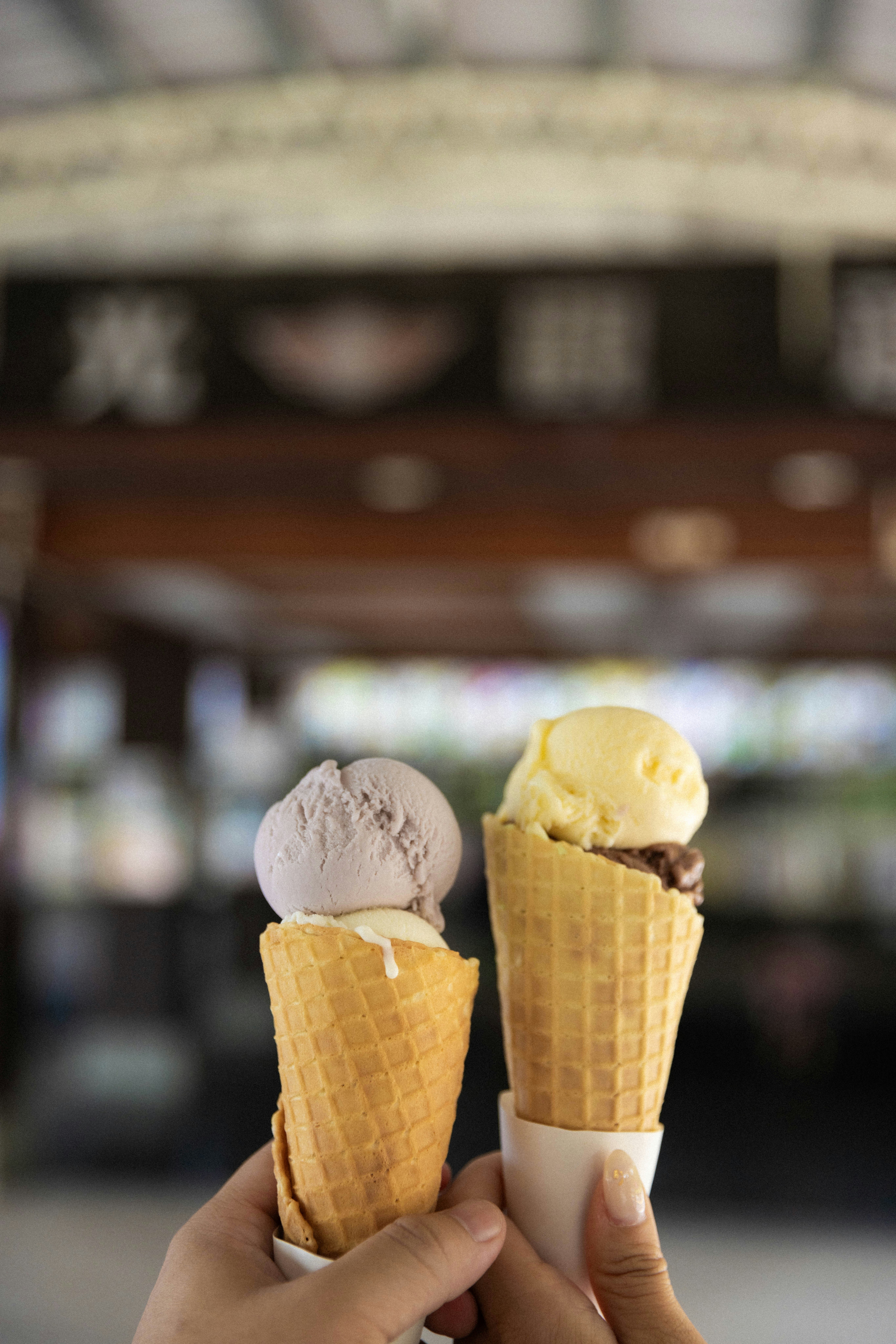A person holding two cones of ice cream photo – Free Cream Image on ...