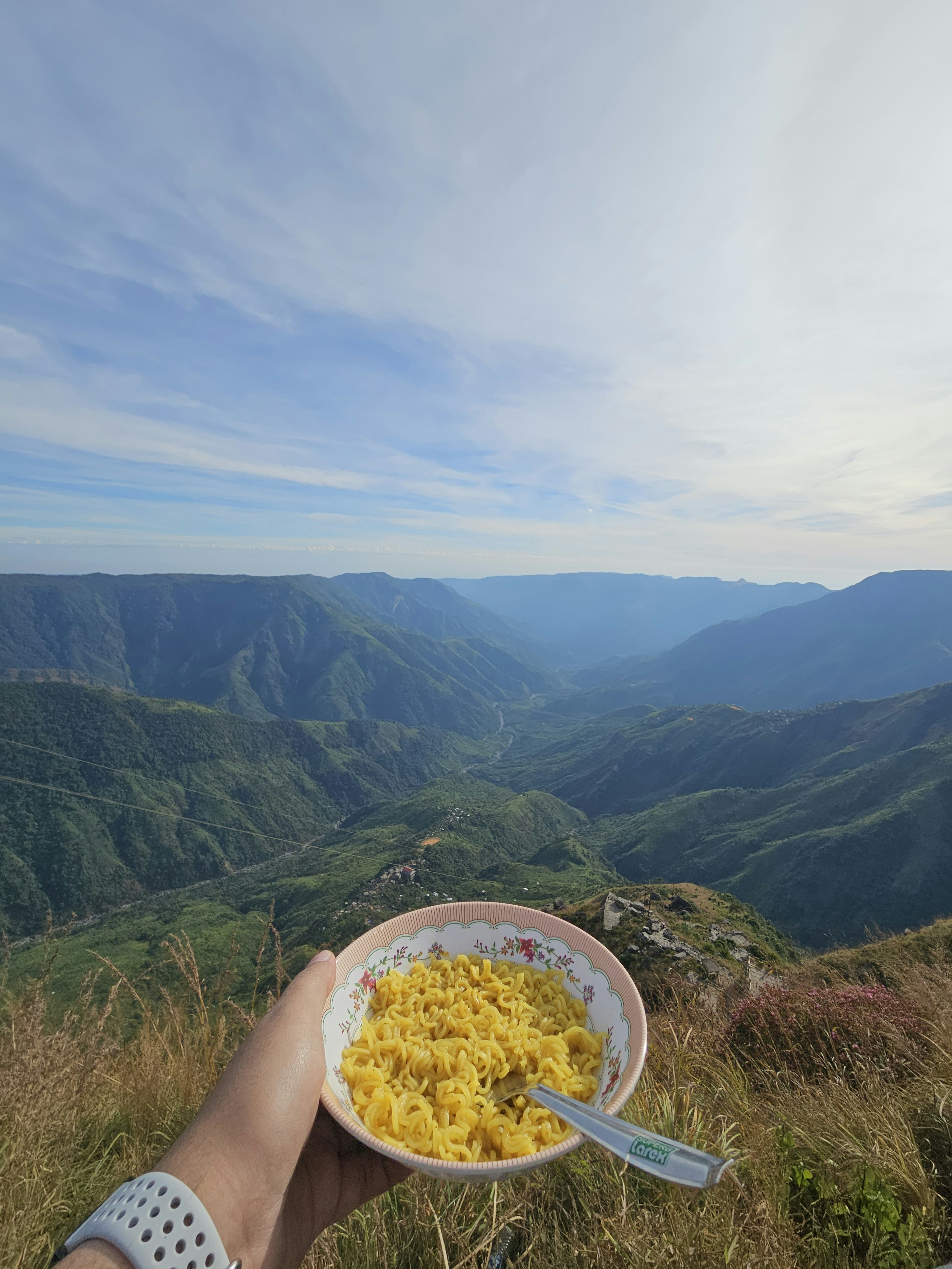 Pasta on the Rim: A Sunlit Summit Over Green Valleys