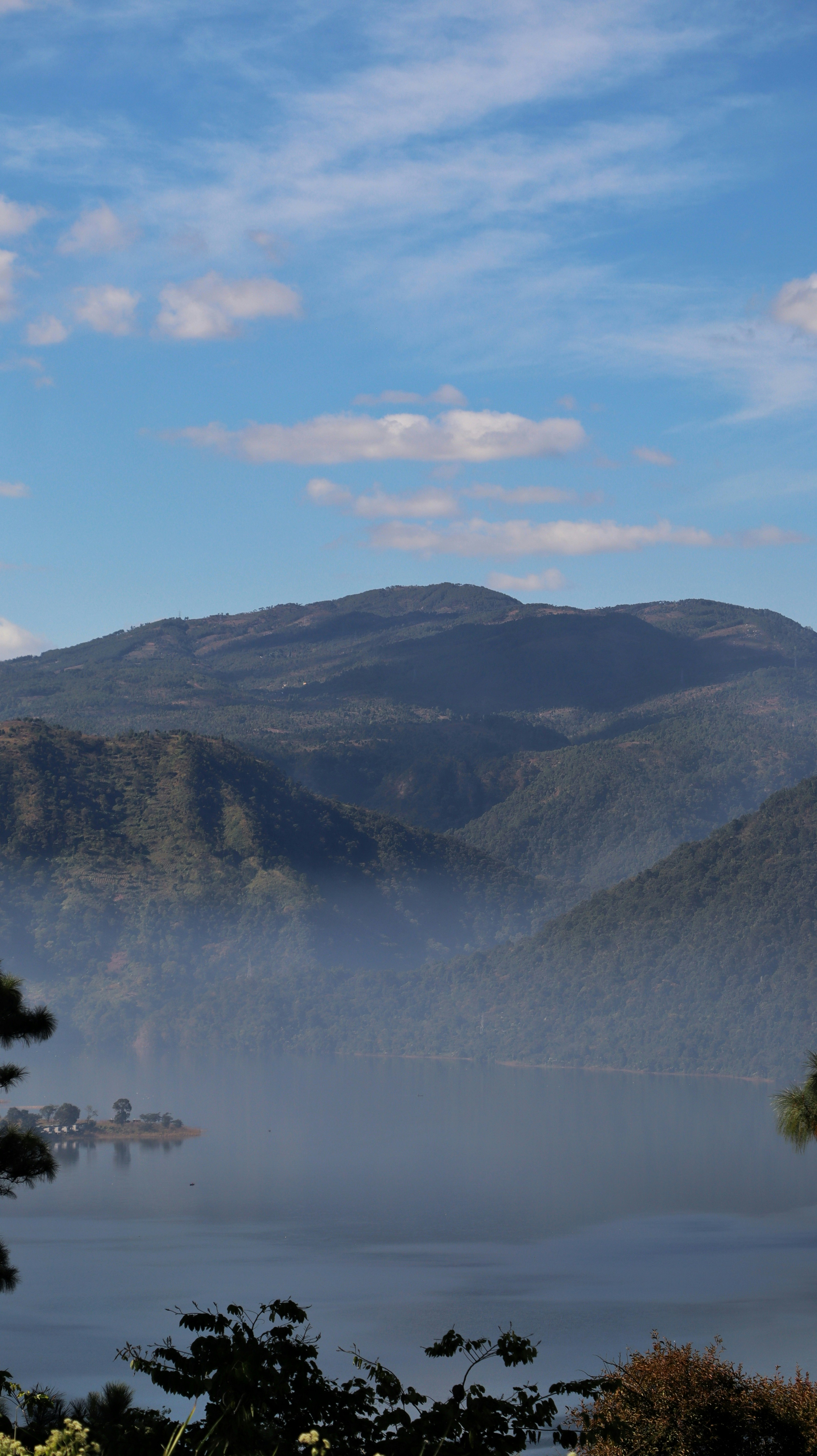 Dawn Mist Drapes a Mountain Ridge over a Mirror Lake