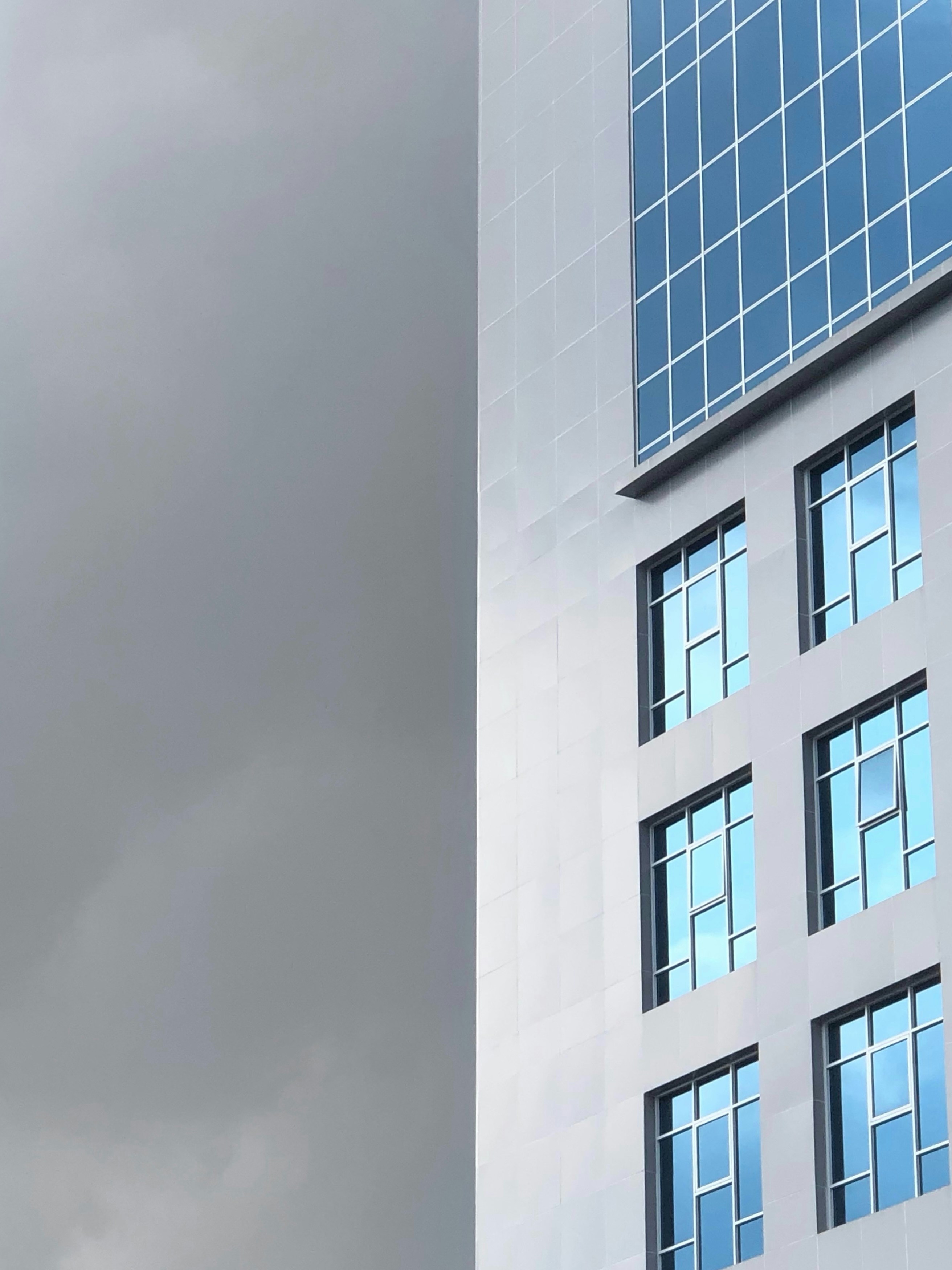 Edge of a Glass-Clad High-Rise Against a Moody Sky