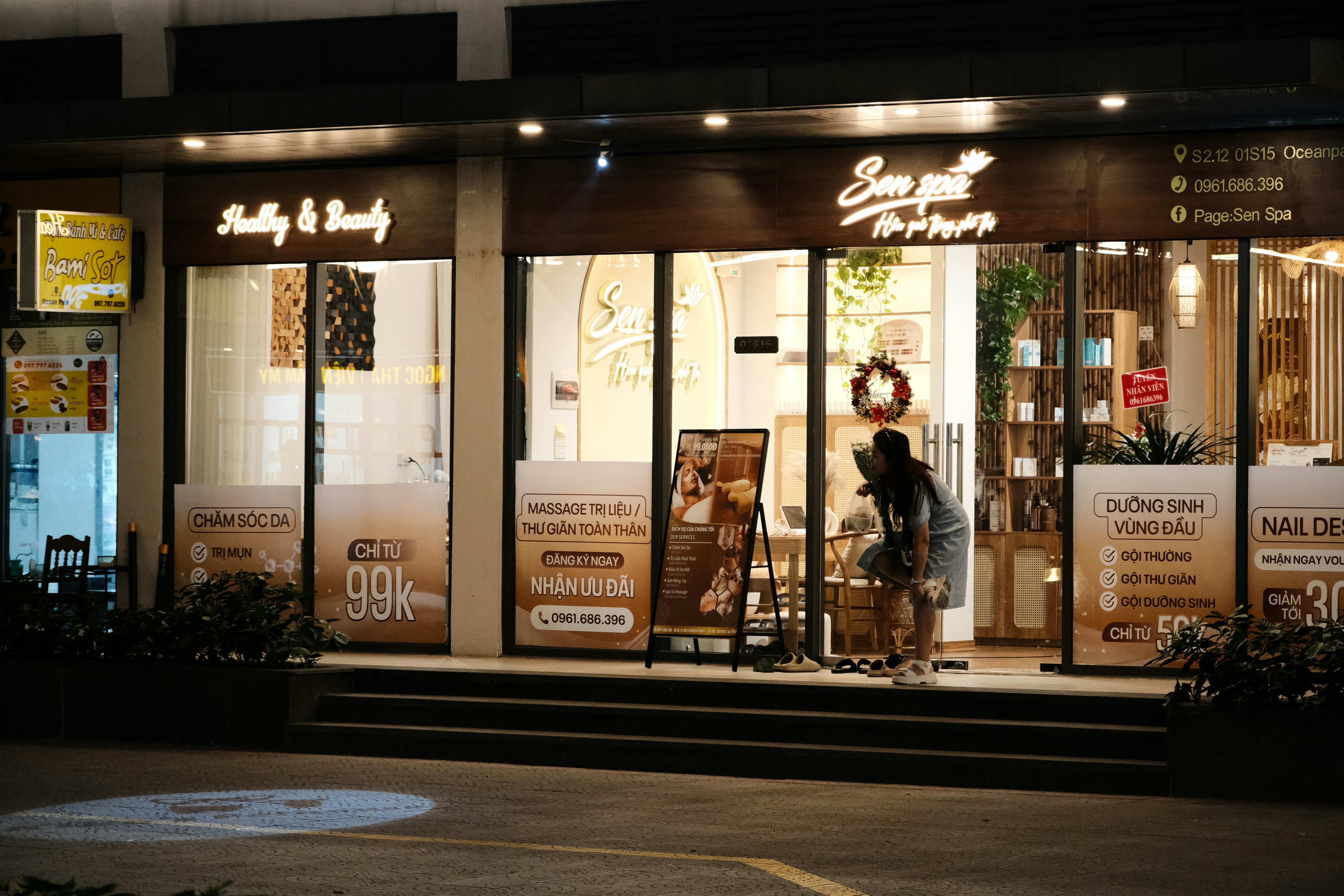 A store front at night with lights on photo – Free Building Image on ...