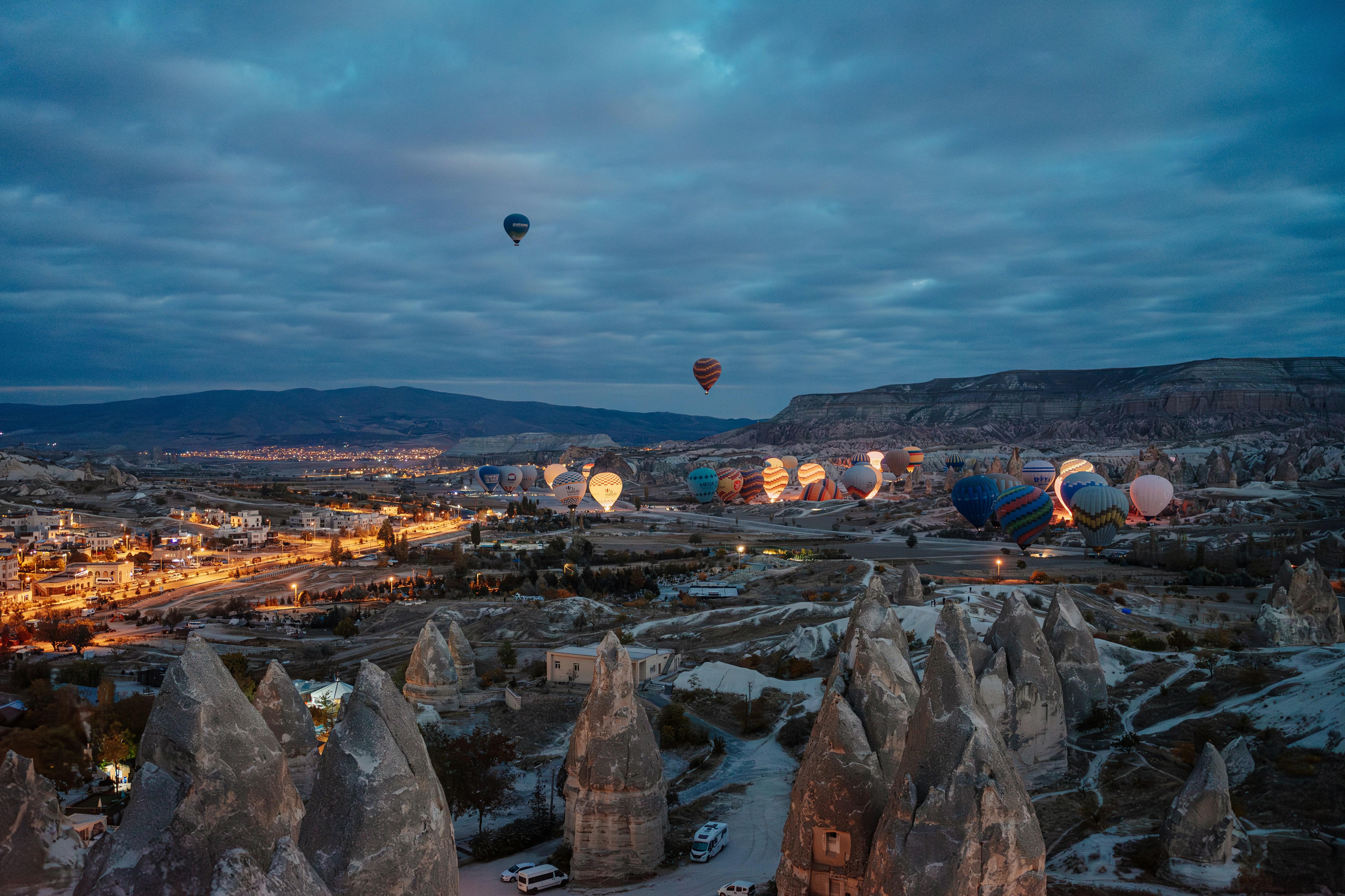 Dawn Lift: Balloons Drift Over Cappadocian Fairy Chimneys