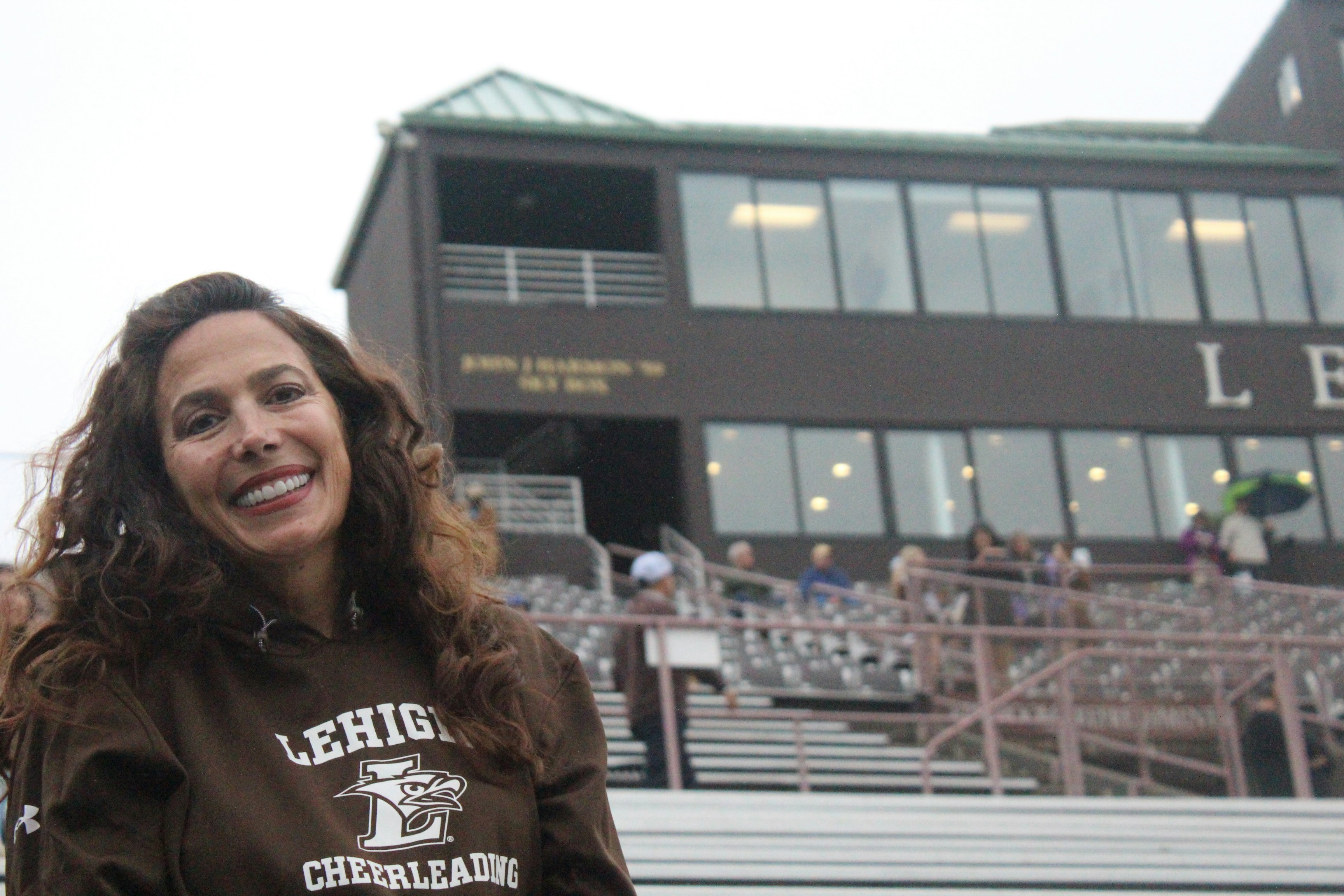 A woman standing in front of a bleachers photo – Free Woman Image on ...