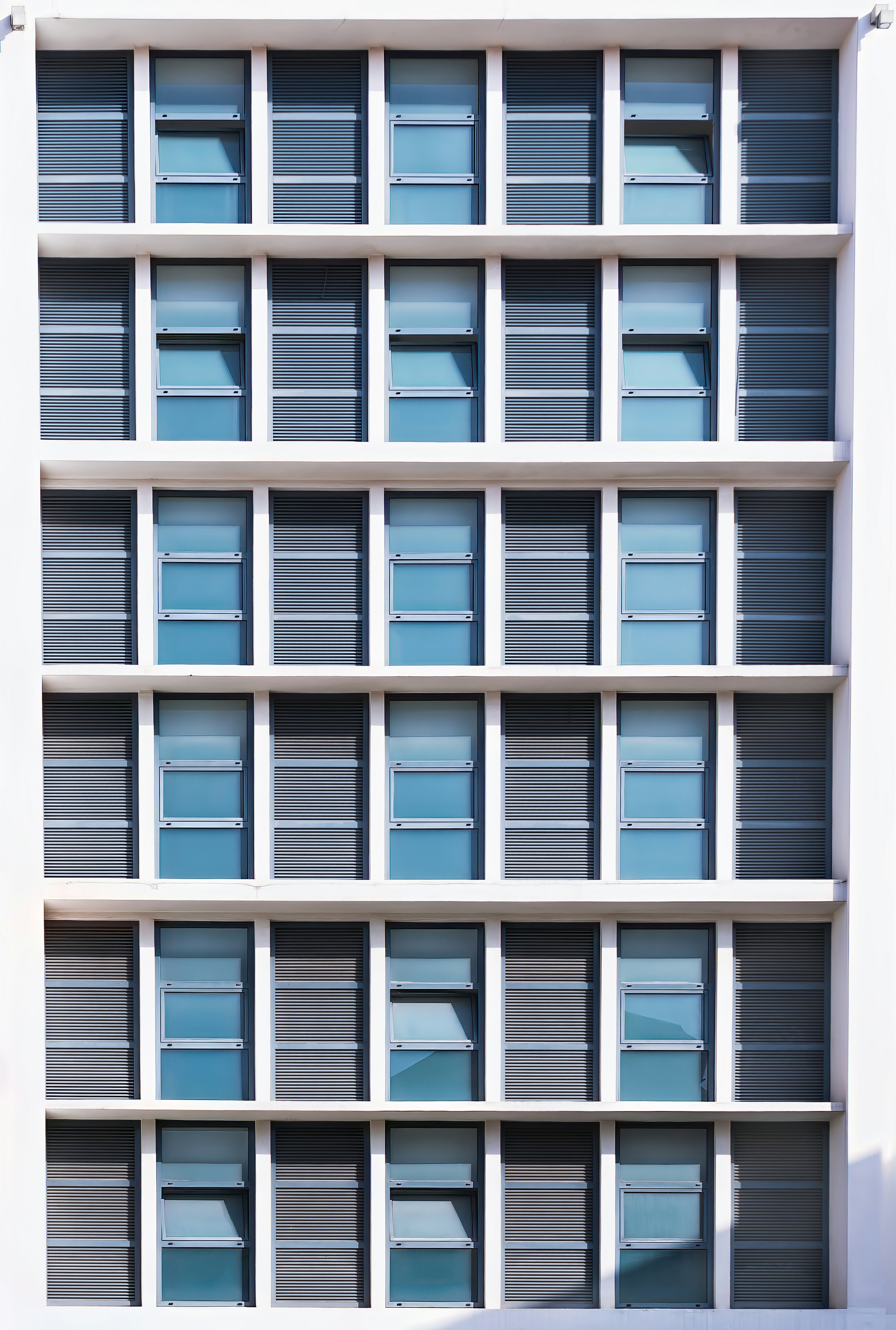 A tall white building with lots of windows photo – Free Wallpaper Image ...