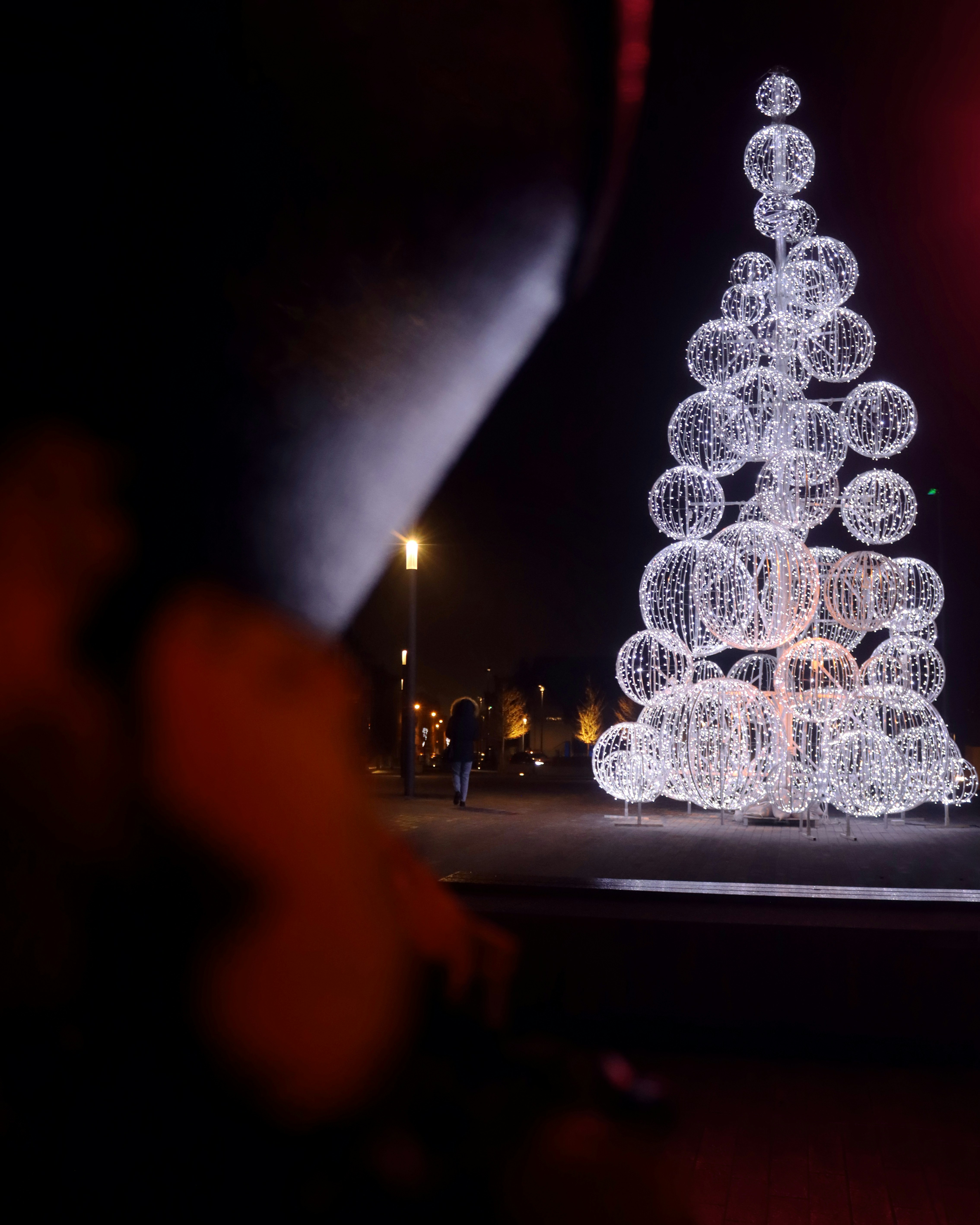 Luminous Glass-Sphere Christmas Tree Illuminates a Quiet Night Plaza
