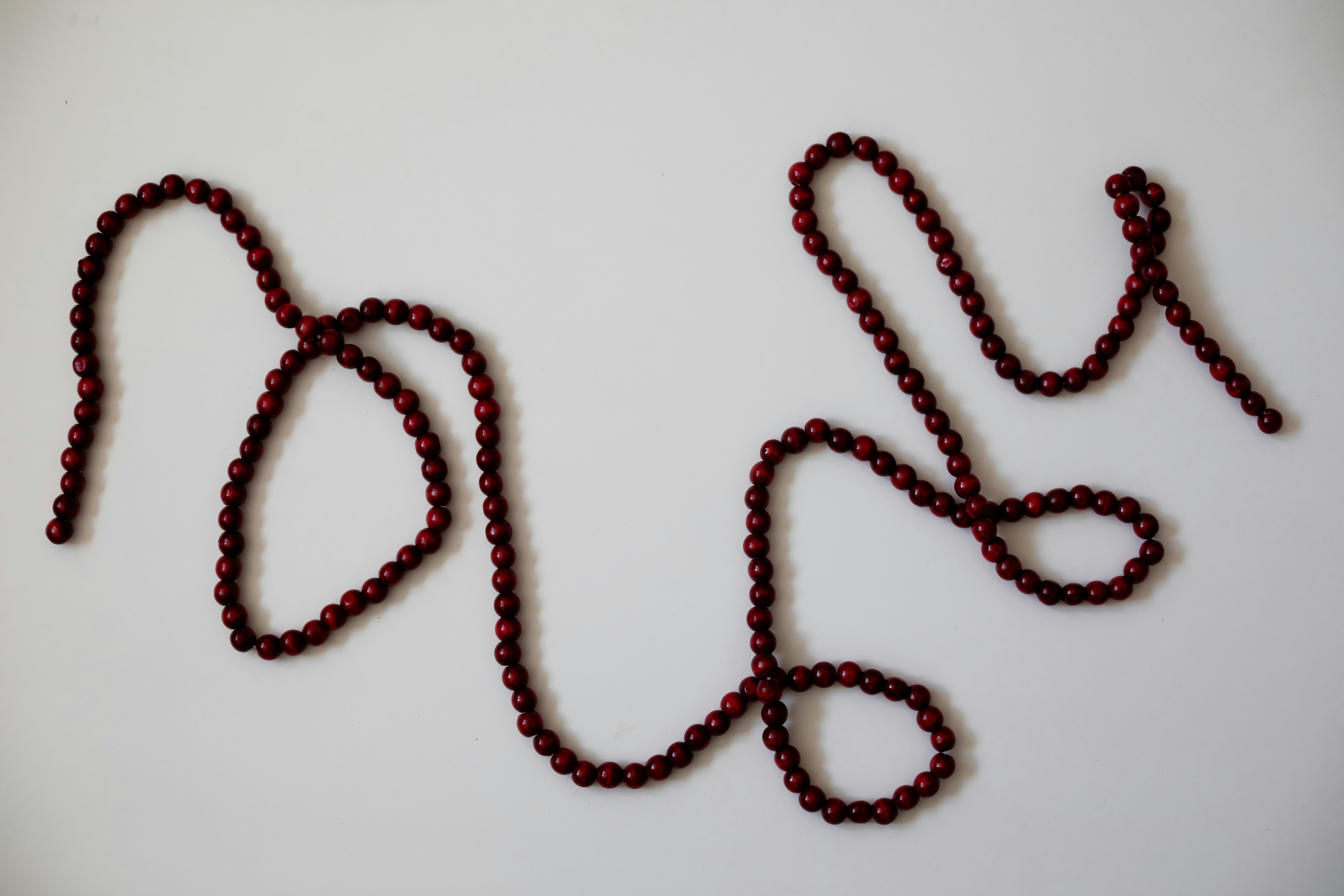 A string of beads with the word joy spelled out of it