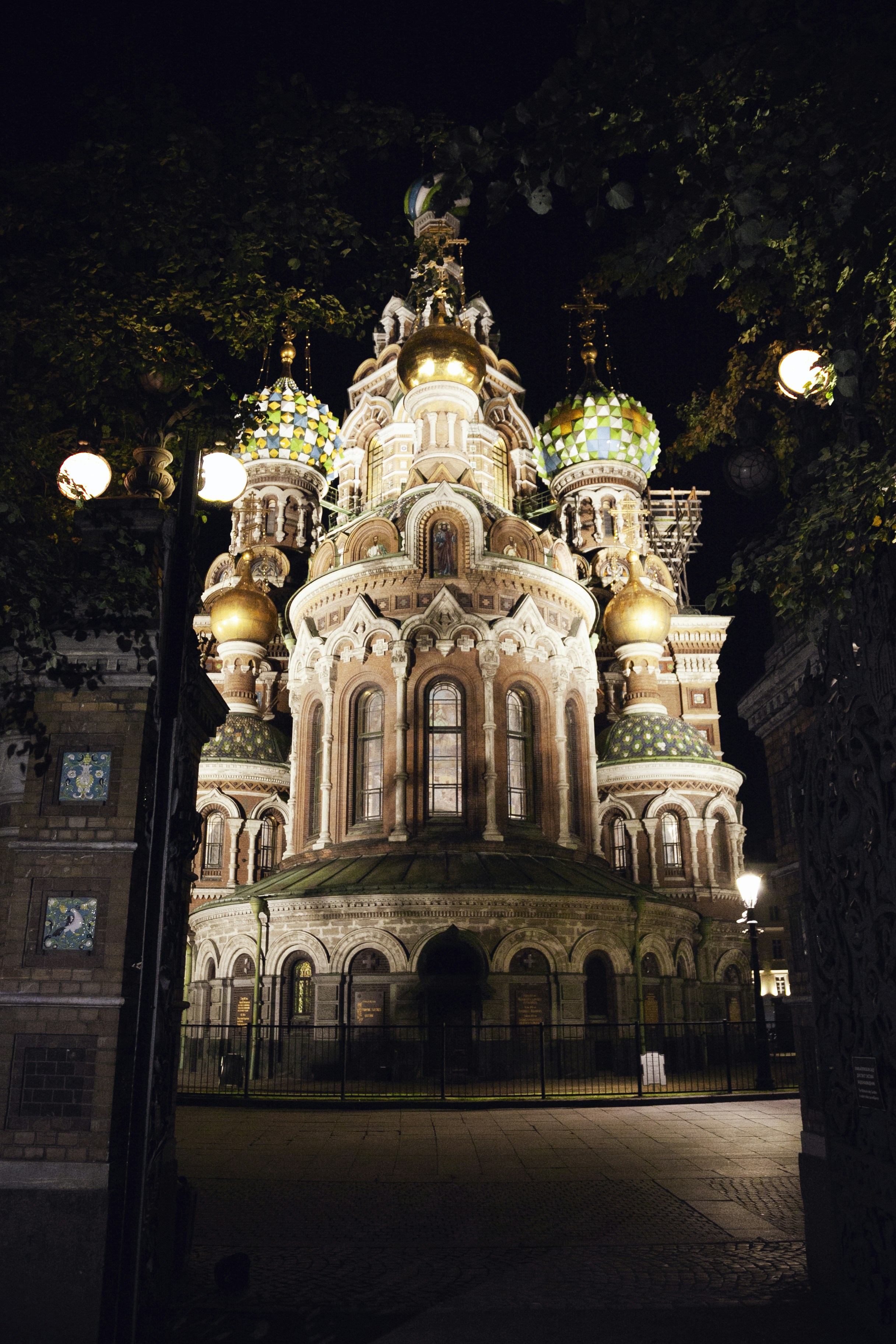 A church lit up at night with street lights photo – Free Building Image ...