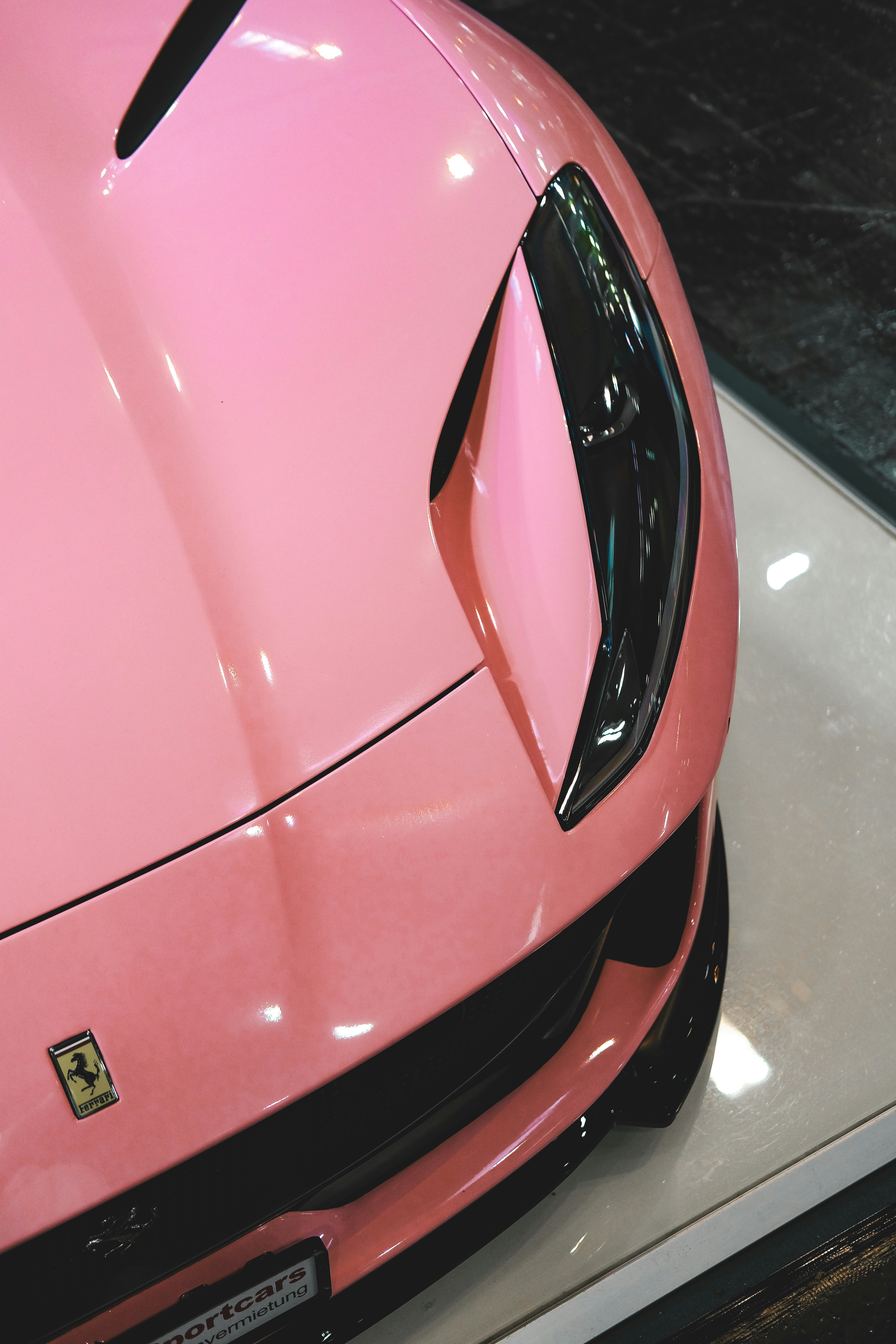 Blush Prancing Horse: Front View of a Pink Ferrari on Display