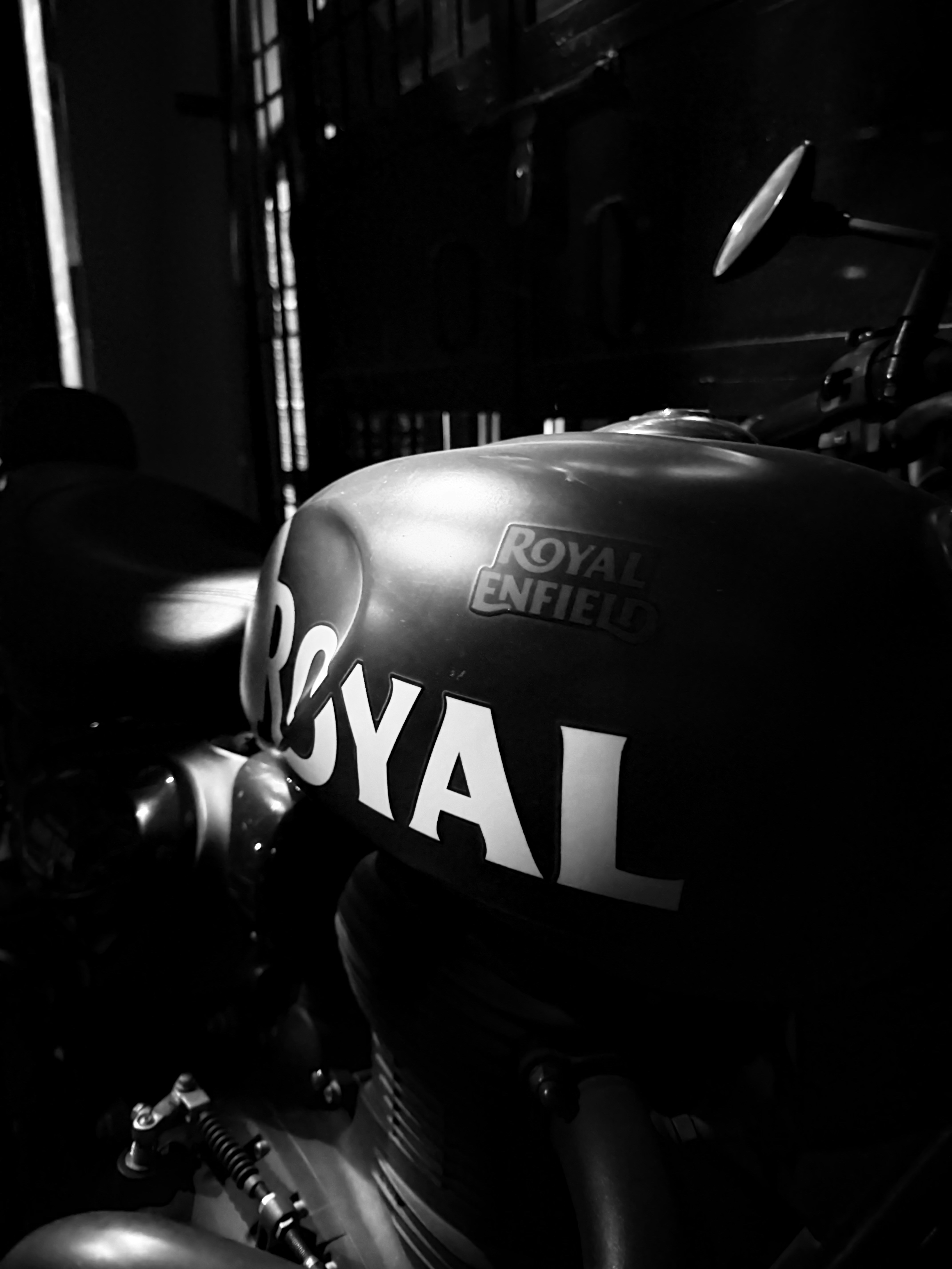 Noir in the Garage: The Royal Enfield Tank Under Shadowed Lights