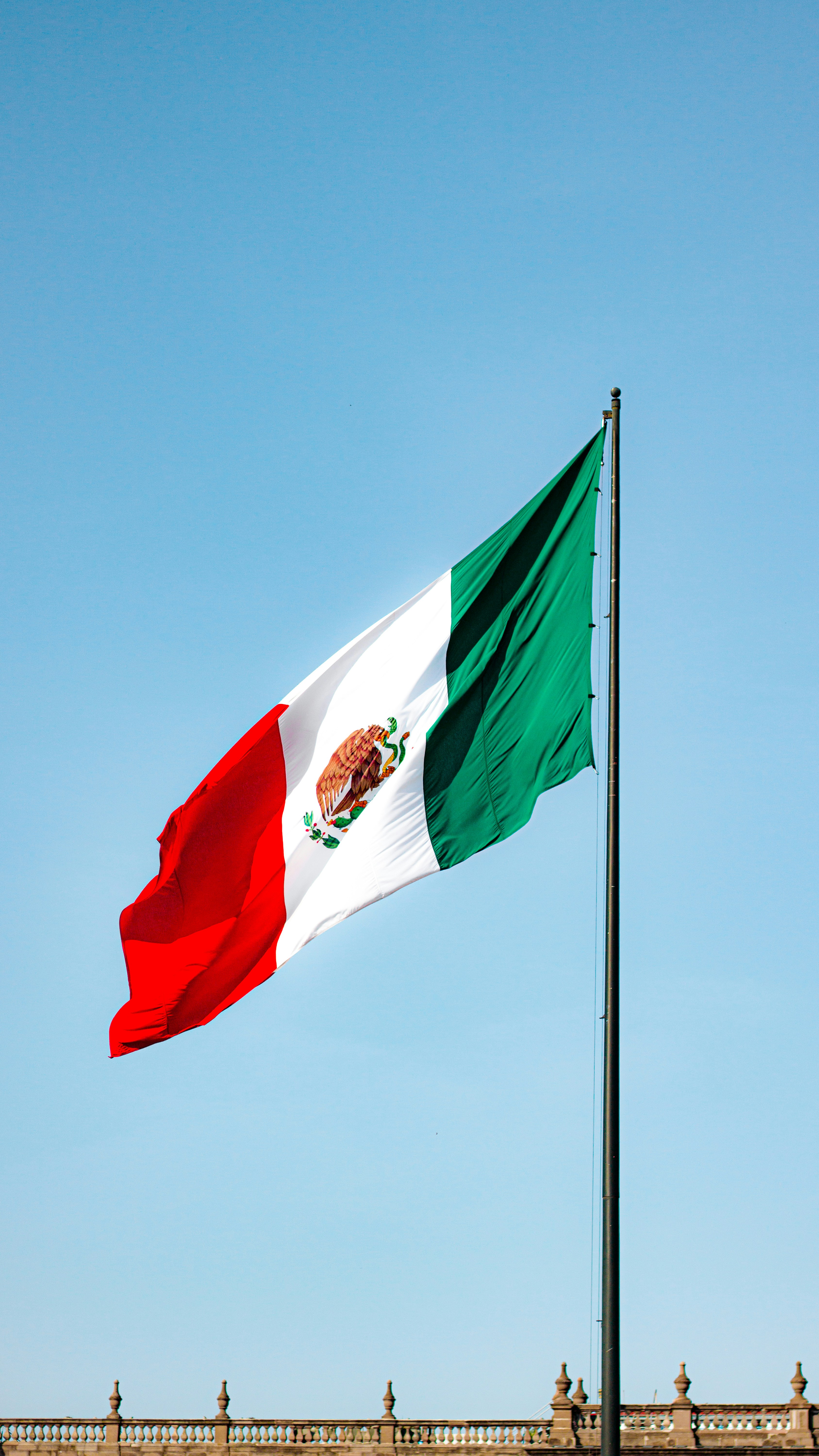 Mexico’s Tricolor Flag Adrift in a Clear Blue Sky