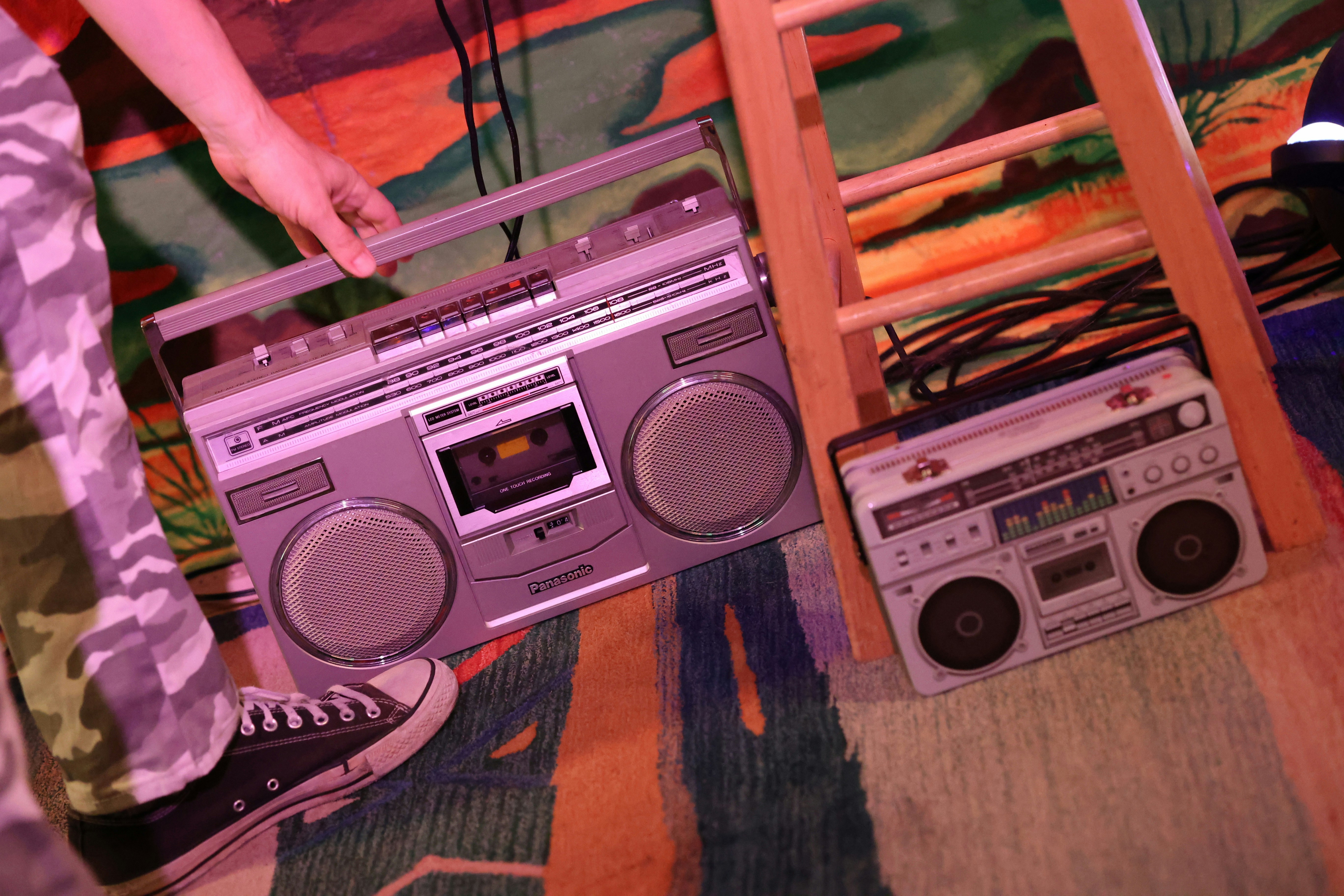 A person standing on top of a ladder next to a boombox photo – Free ...