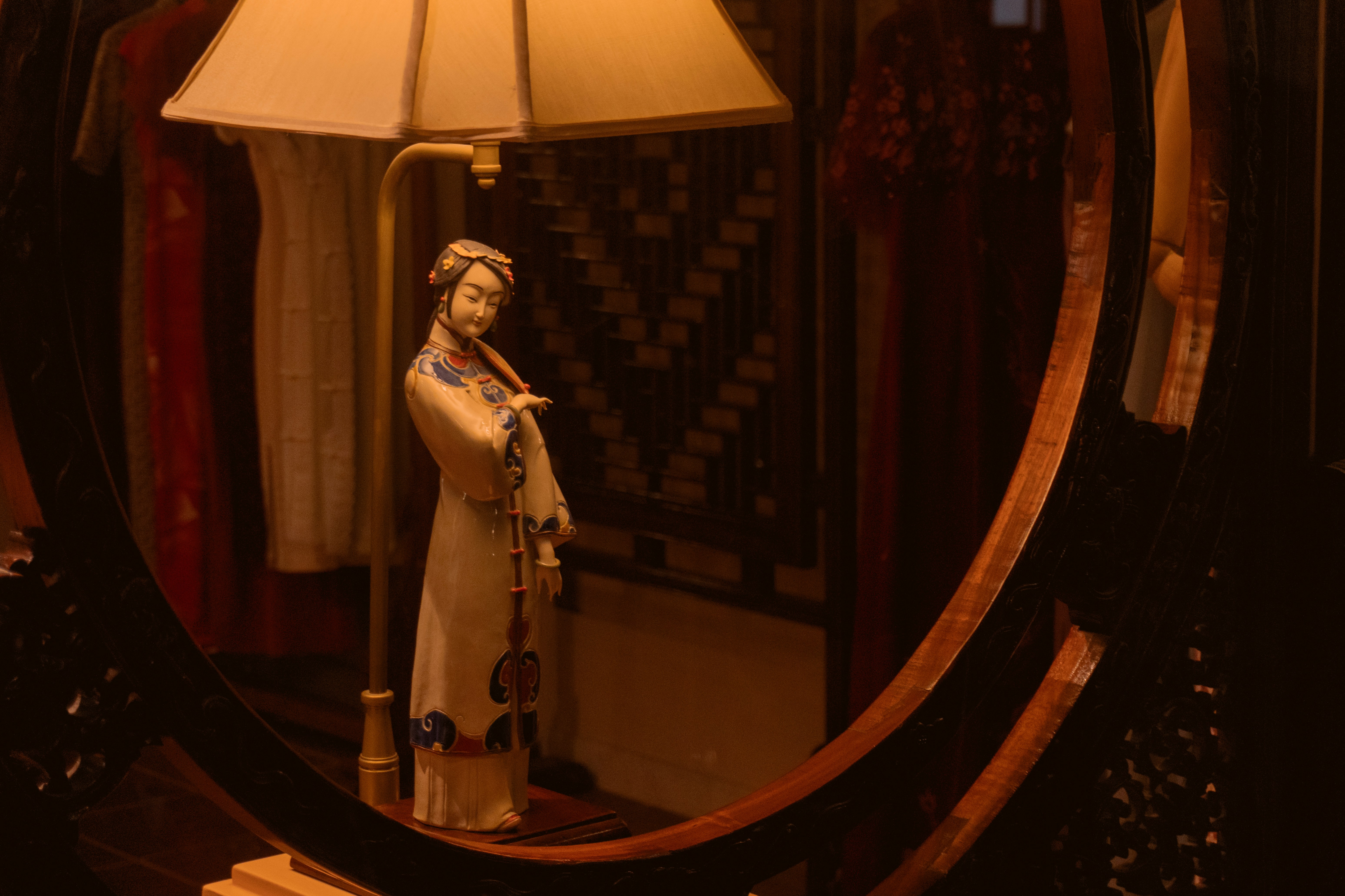 Amber Ring, Quiet Figure: A Porcelain Moment in Warm Light