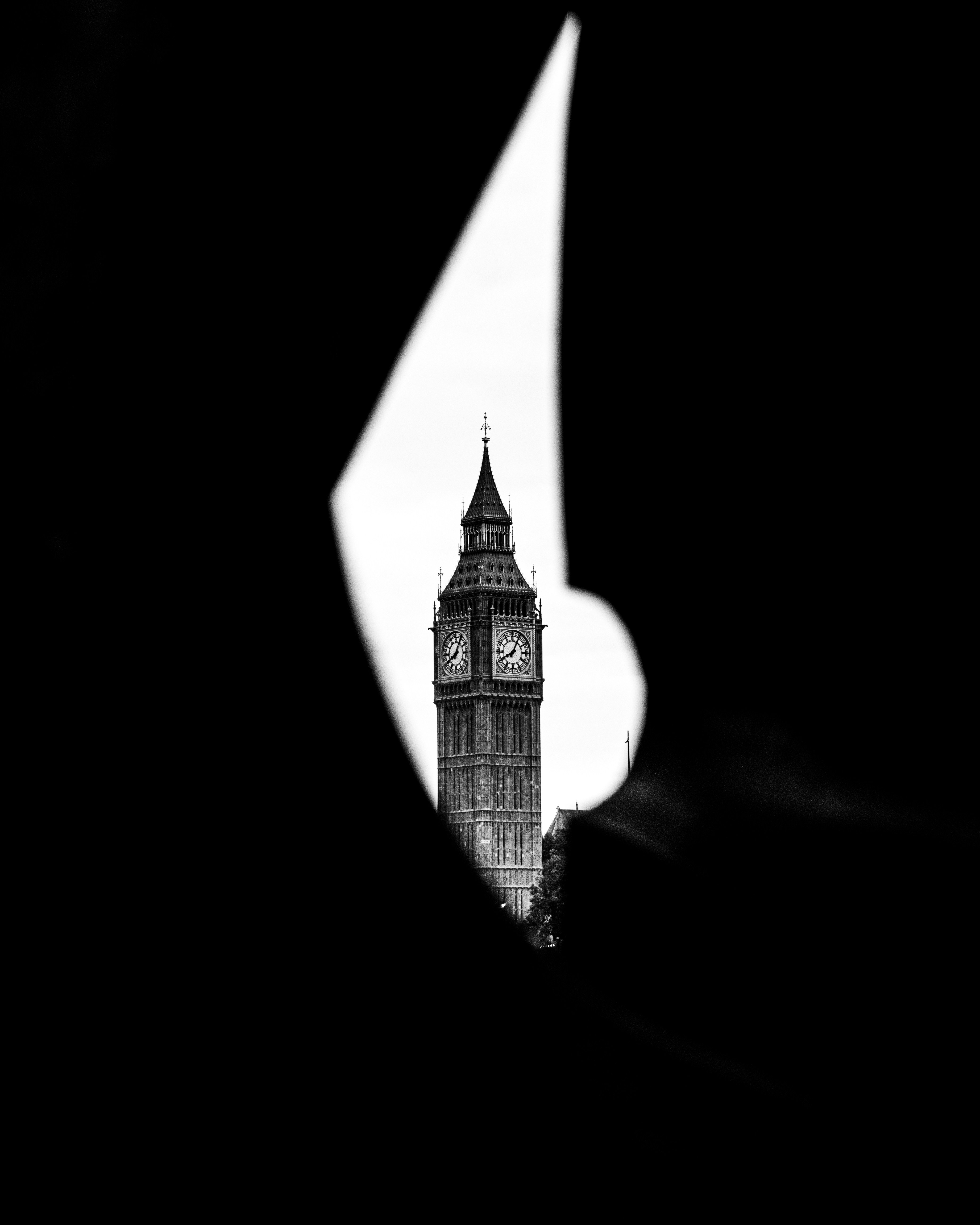 Clock tower (Big Ben) peeks through a stark curved silhouette, creating a dramatic negative-space frame around the landmark.