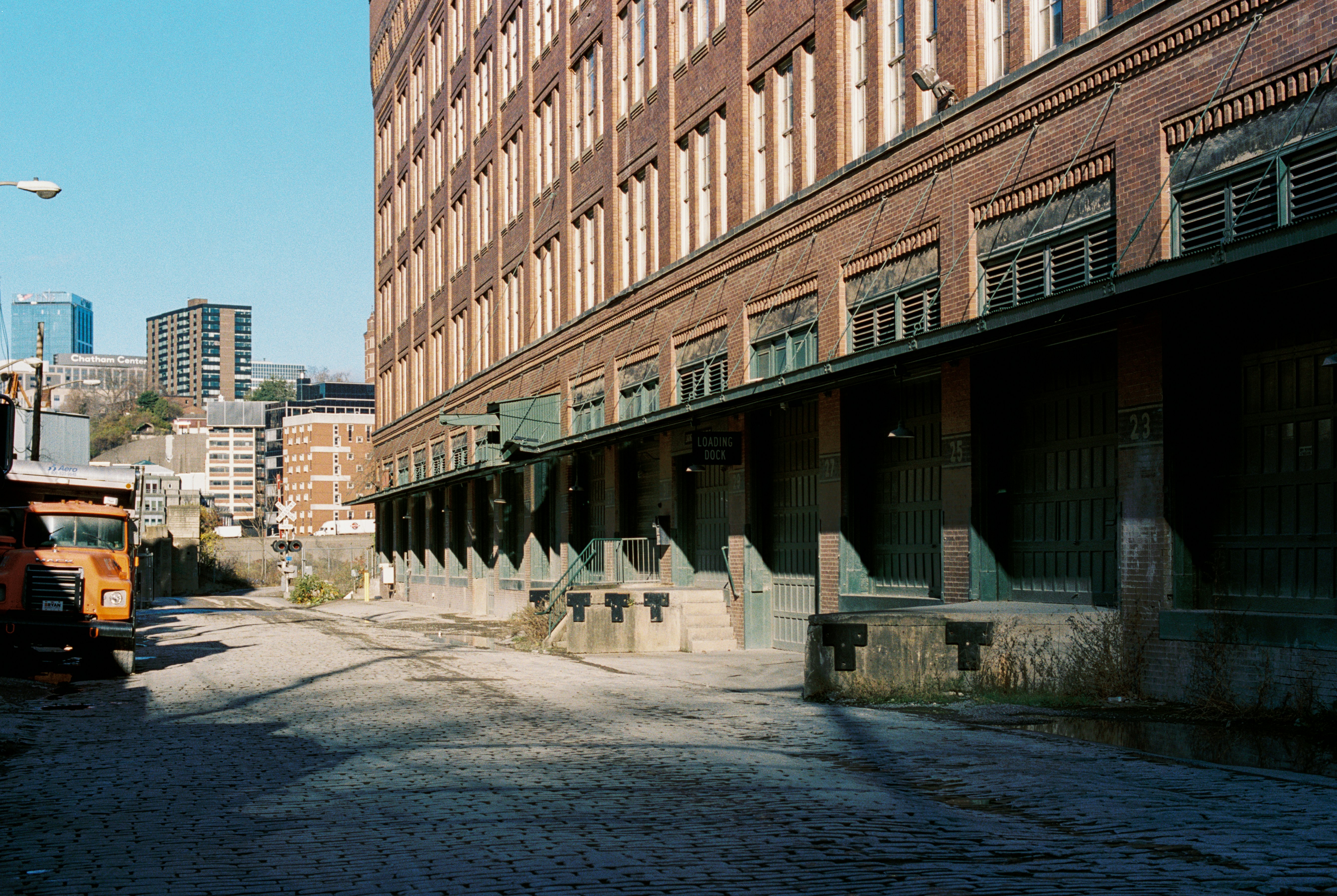 A large brick building next to a very tall building photo – Free ...