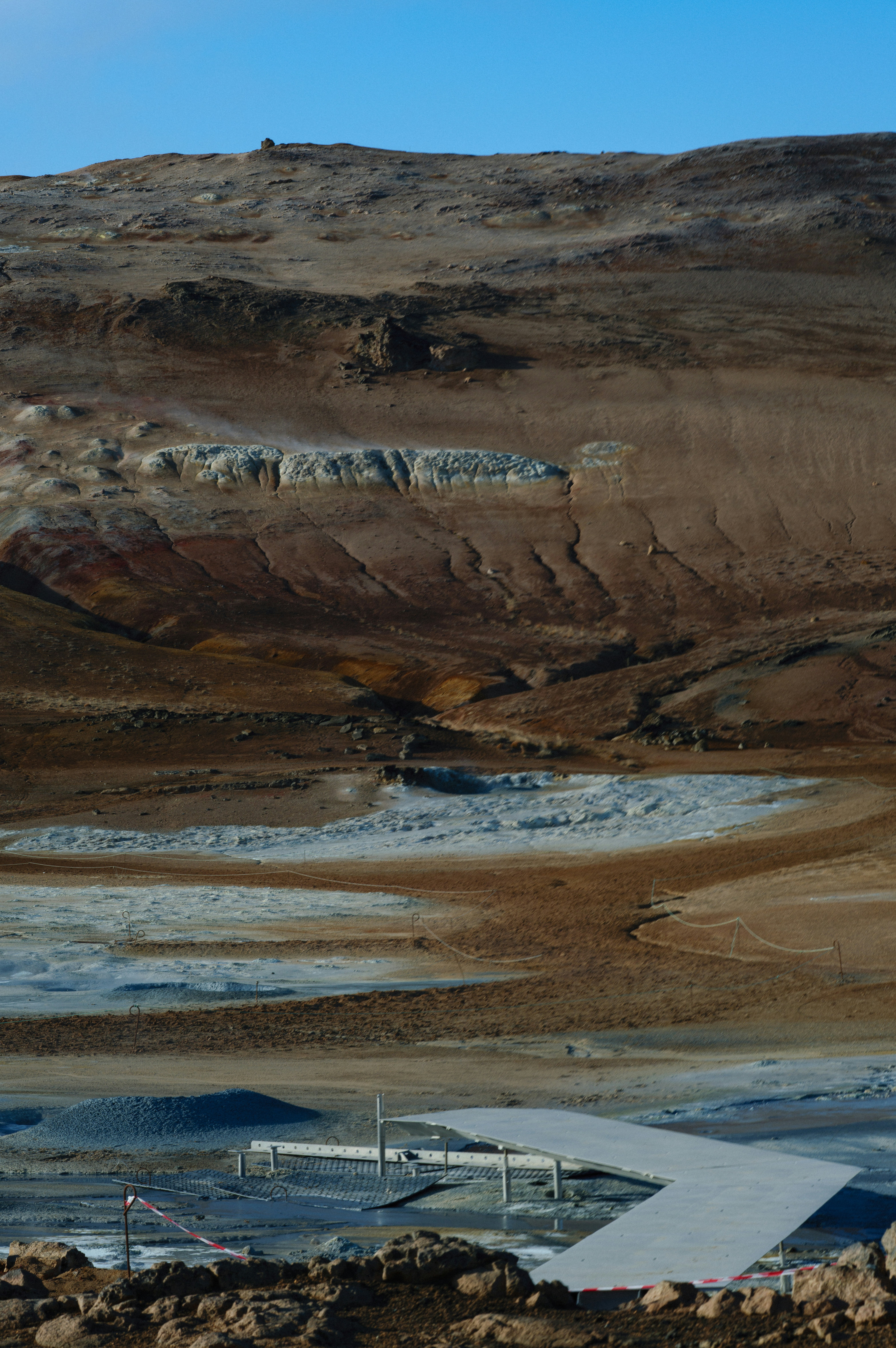 A barren landscape with a few buildings in the distance photo – Free ...