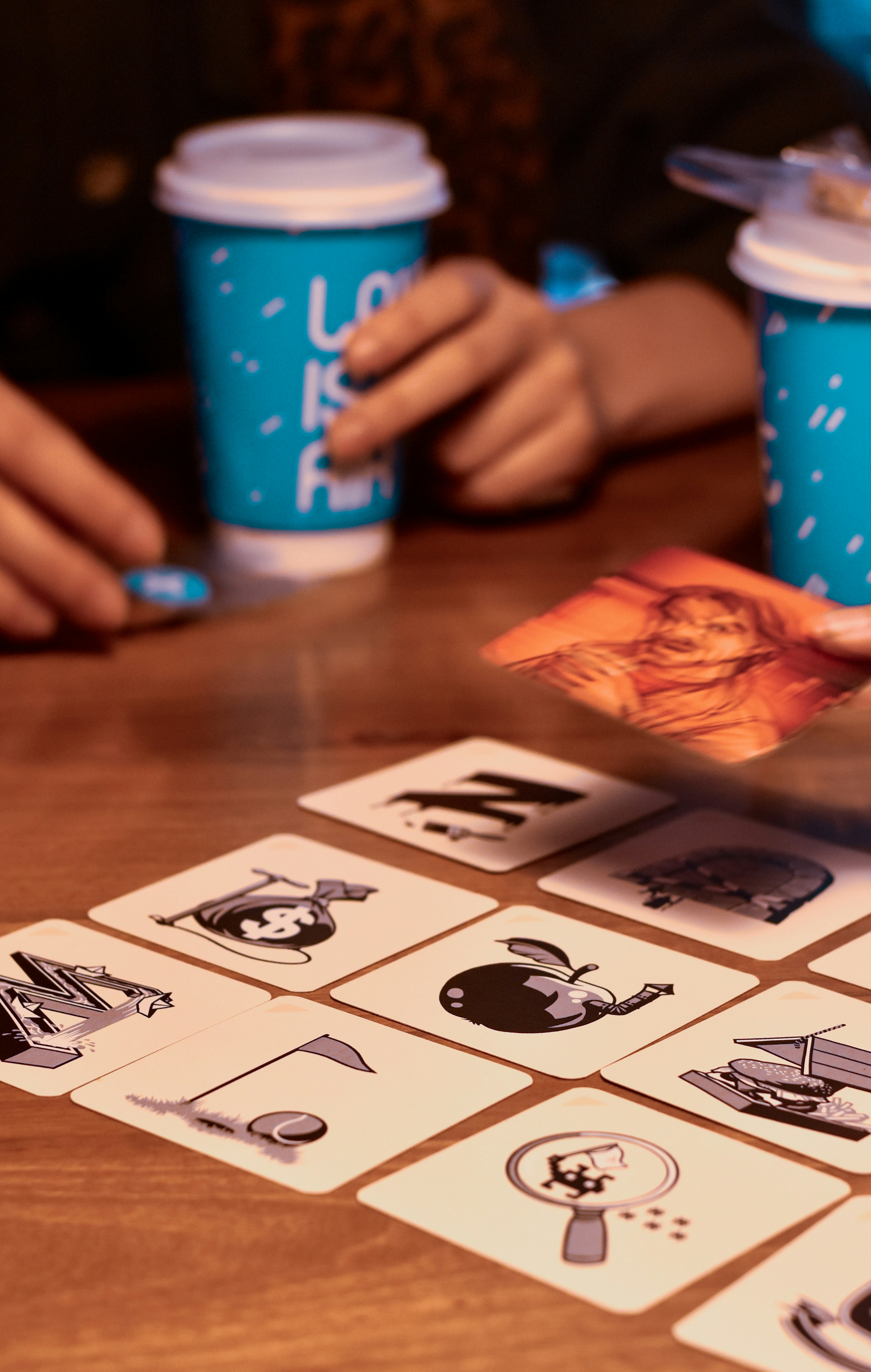 A group of people sitting around a table with cups of coffee