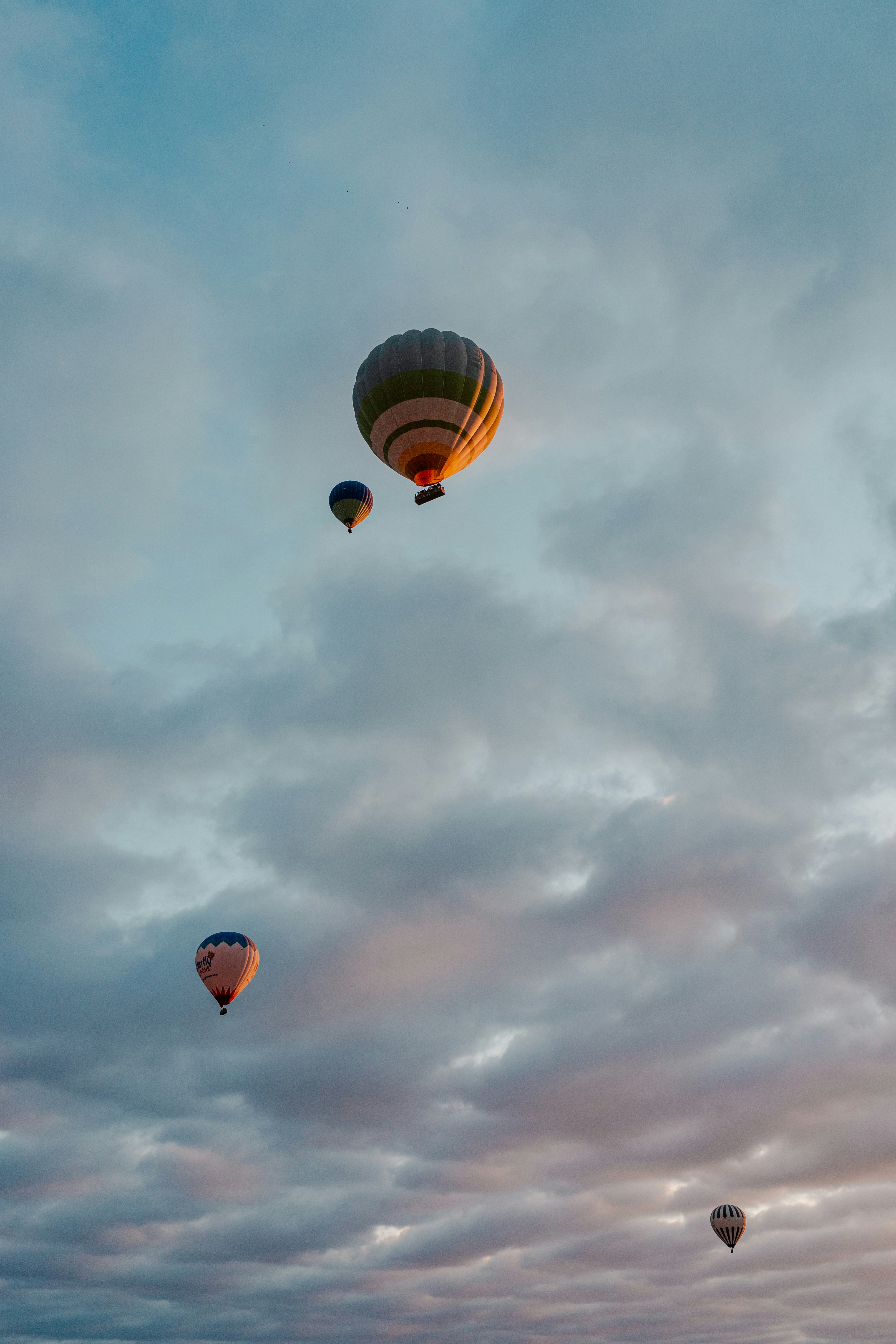 Leading Stripes: A Prominent Balloon Traverses a Quiet Sky