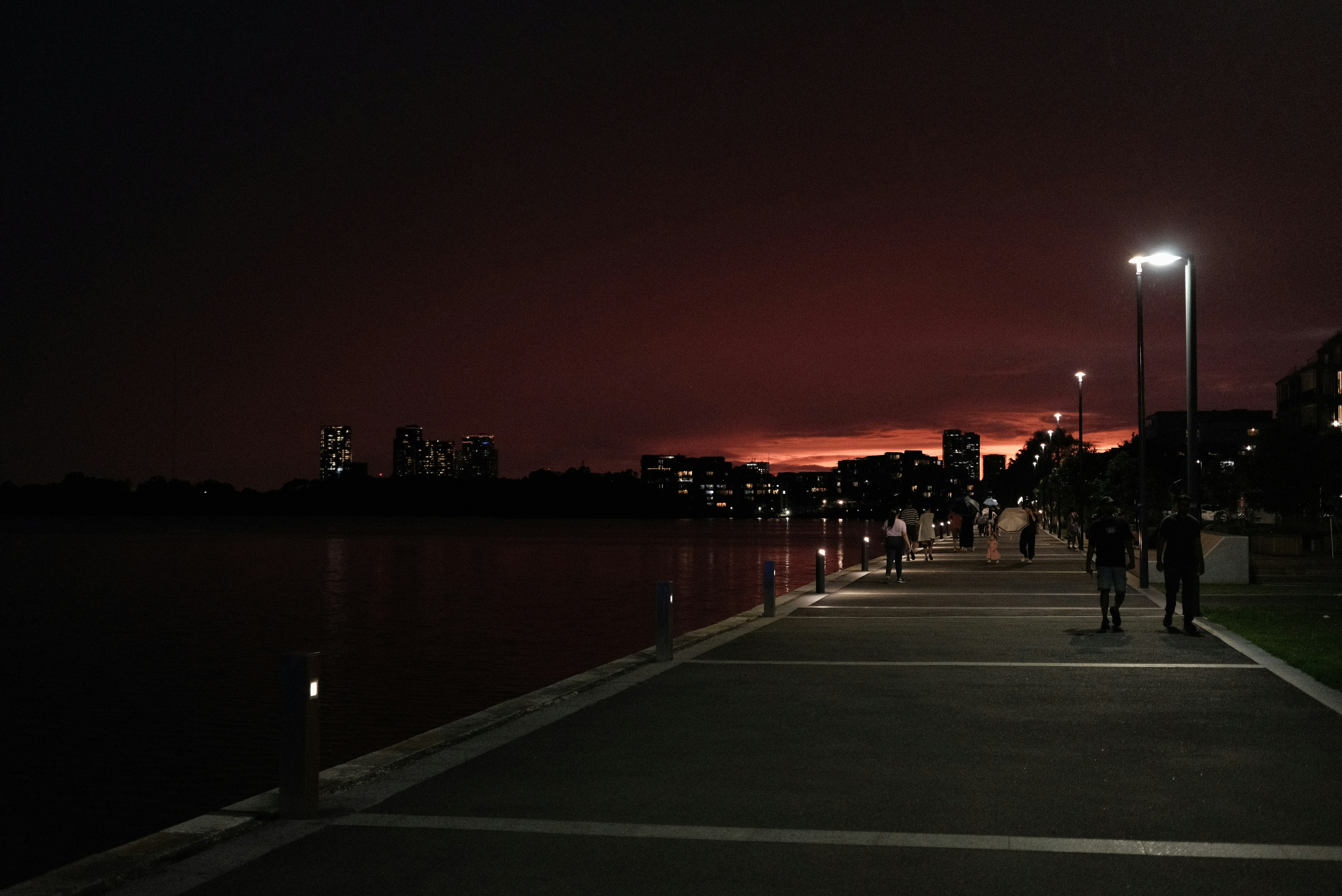 Red-Horizon Promenade: Night Walk Along a Quiet Waterfront