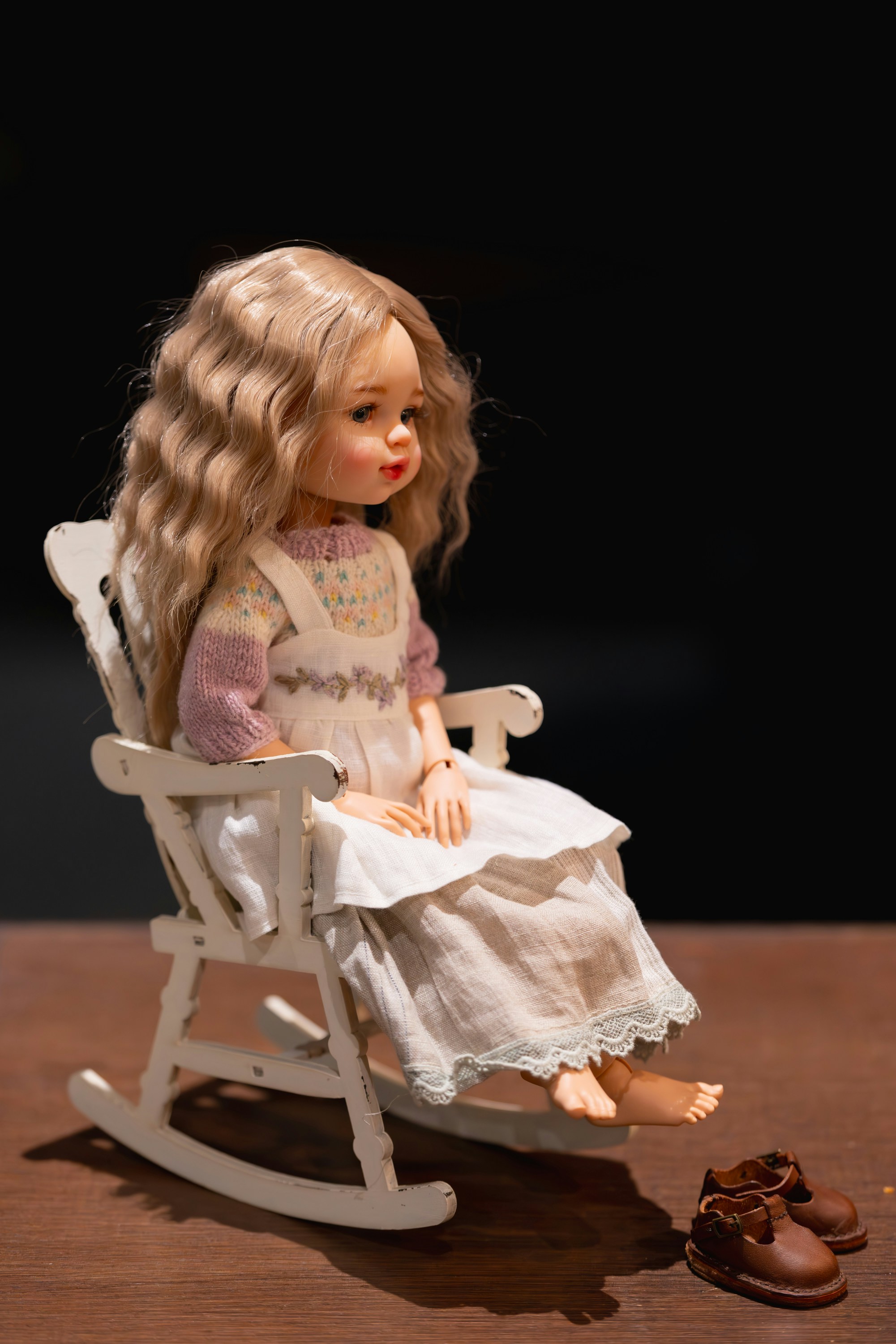 Soft-lit Solitude: The Porcelain Doll Reposes in a White Rocker