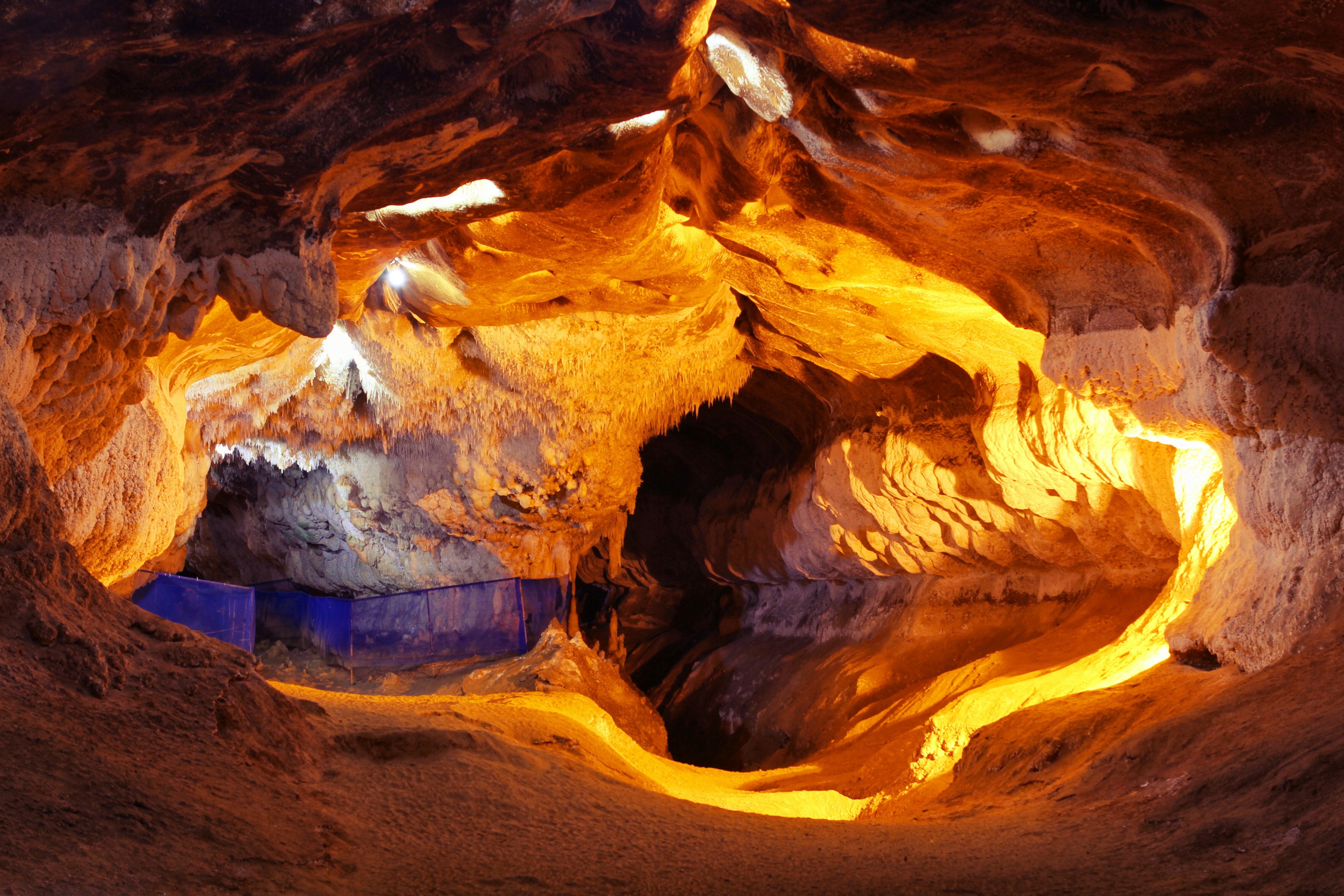 A cave filled with lots of rocks and water photo – Free Cave Image on ...
