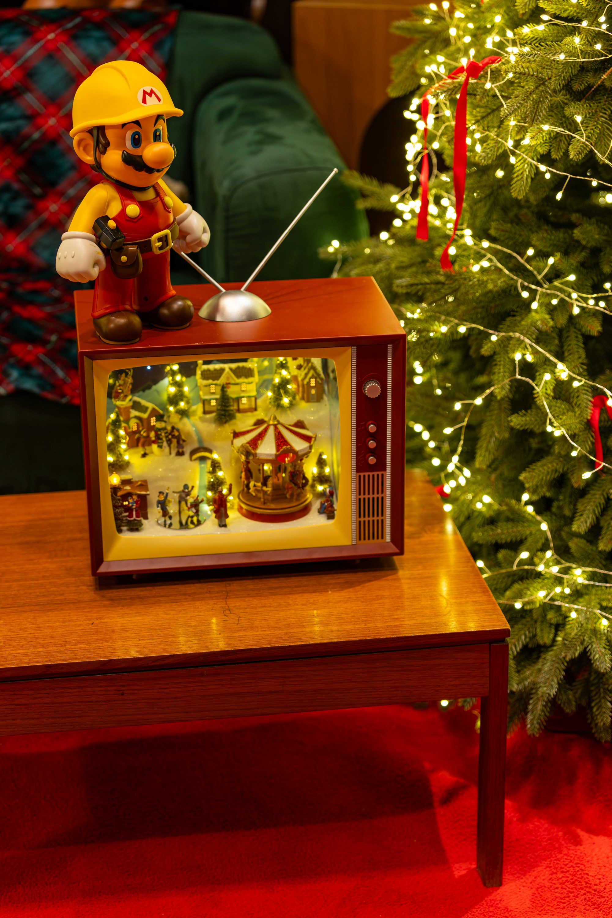 Mario Keeps Watch Over a Tiny Christmas Scene in a Vintage TV