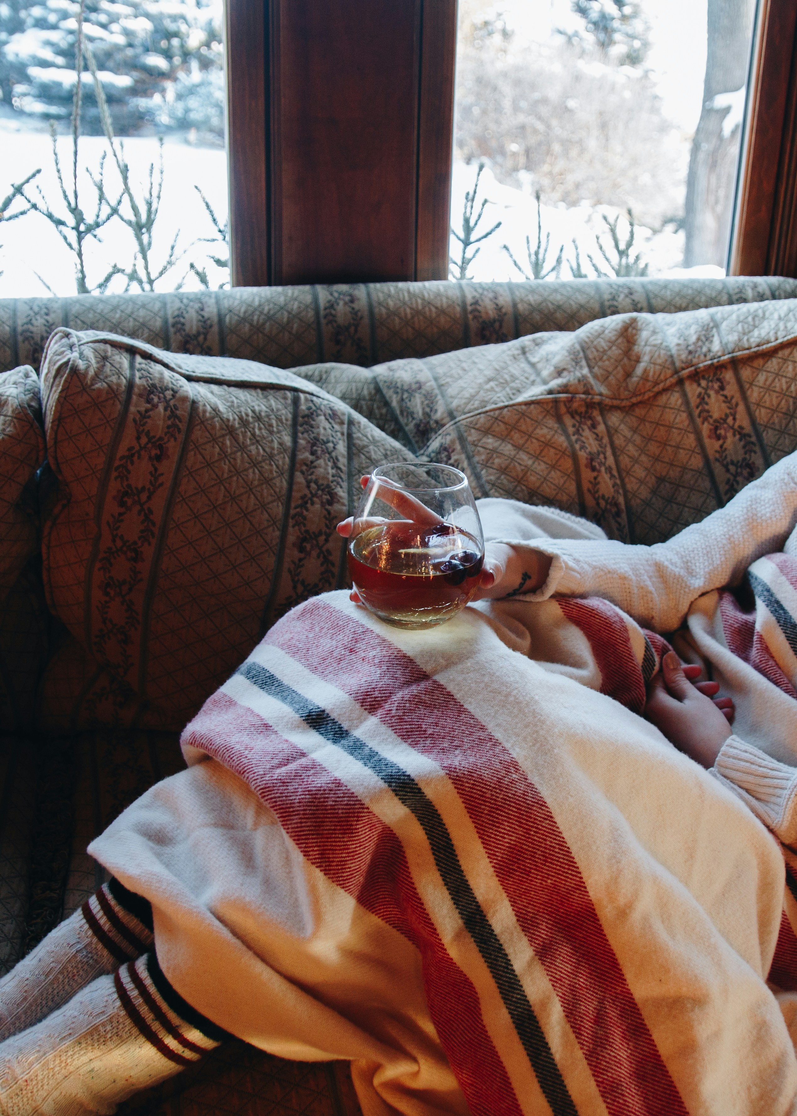 Cozy Cabaret: A Glass of Warmth on a Snowy Window Sill