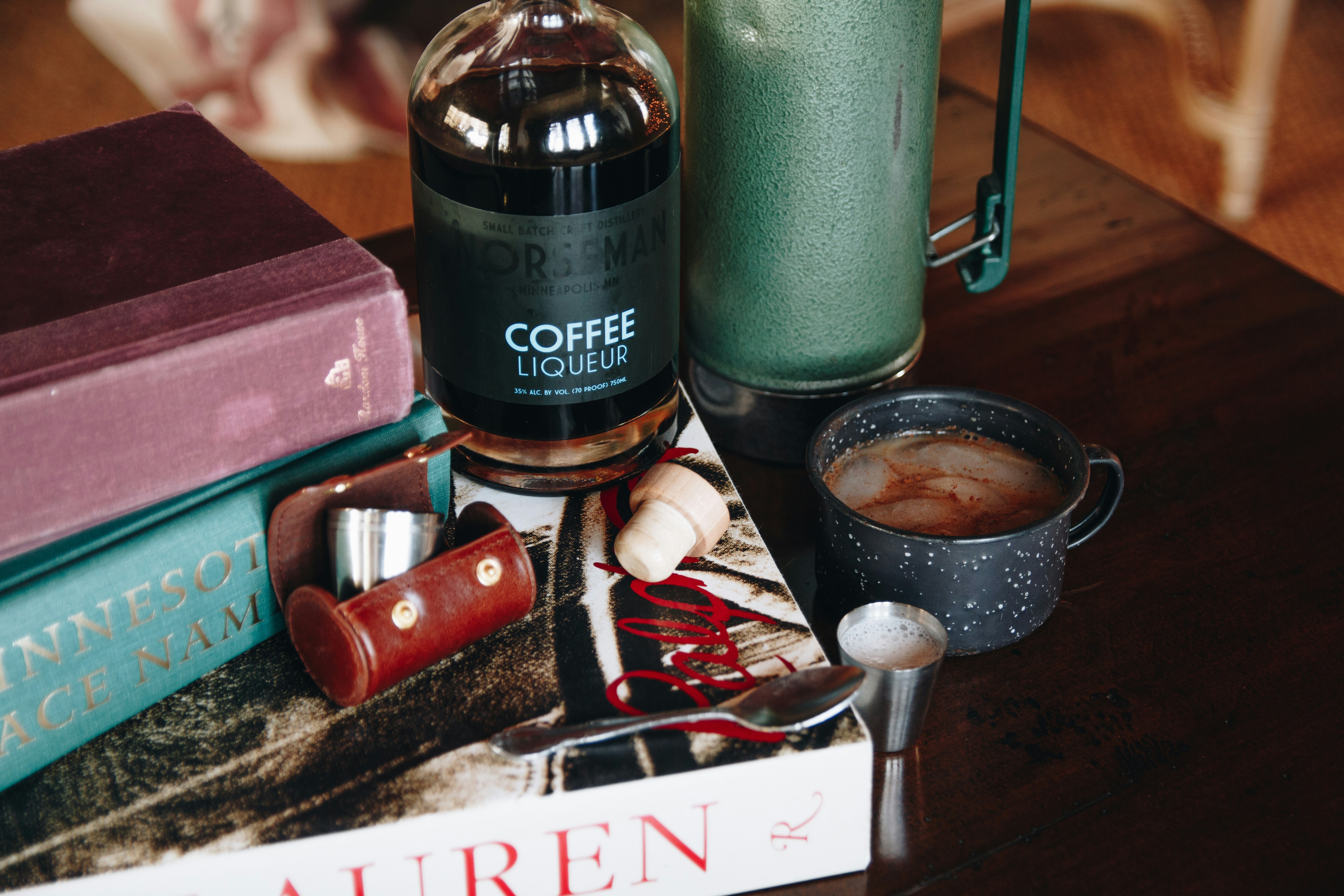 Quiet Alchemy on a Wooden Desk: Coffee Liqueur Amid Books and Steam