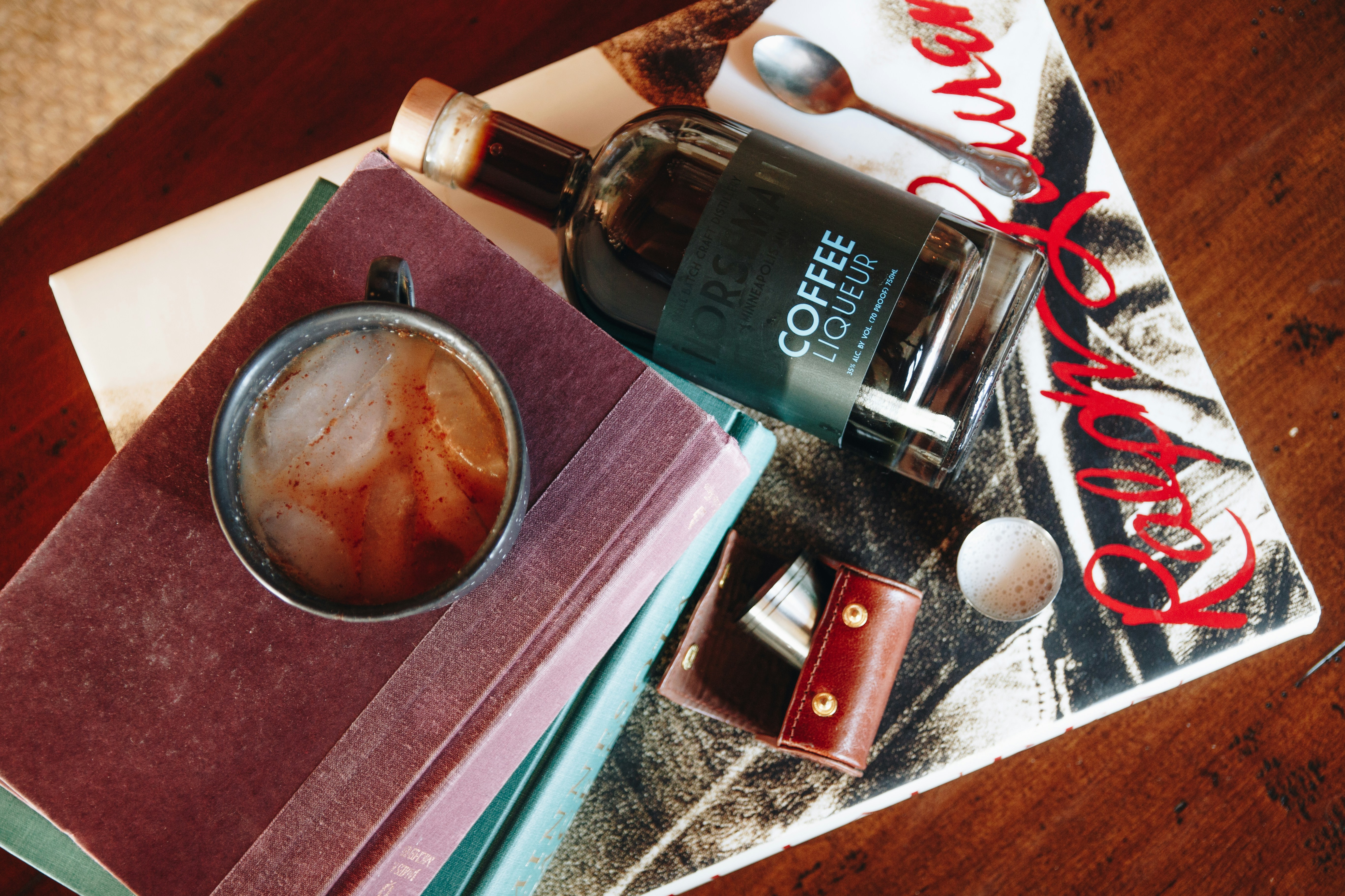 Deskbound Libation: A Coffee Liqueur Still Life Among Books