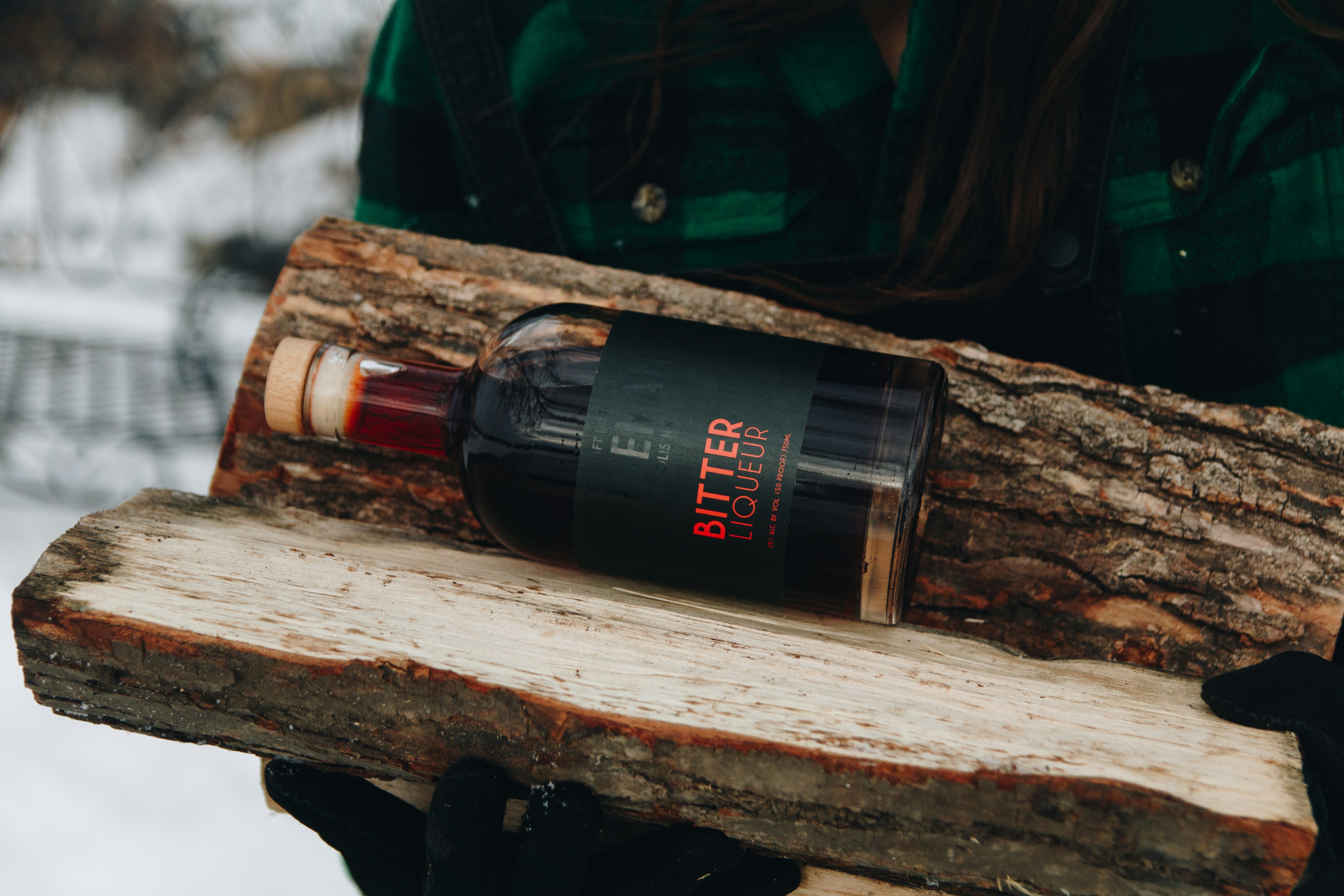 Winter Ledger: Log, Bottle, and Hidden Flame of Orange on Chestnut Bark