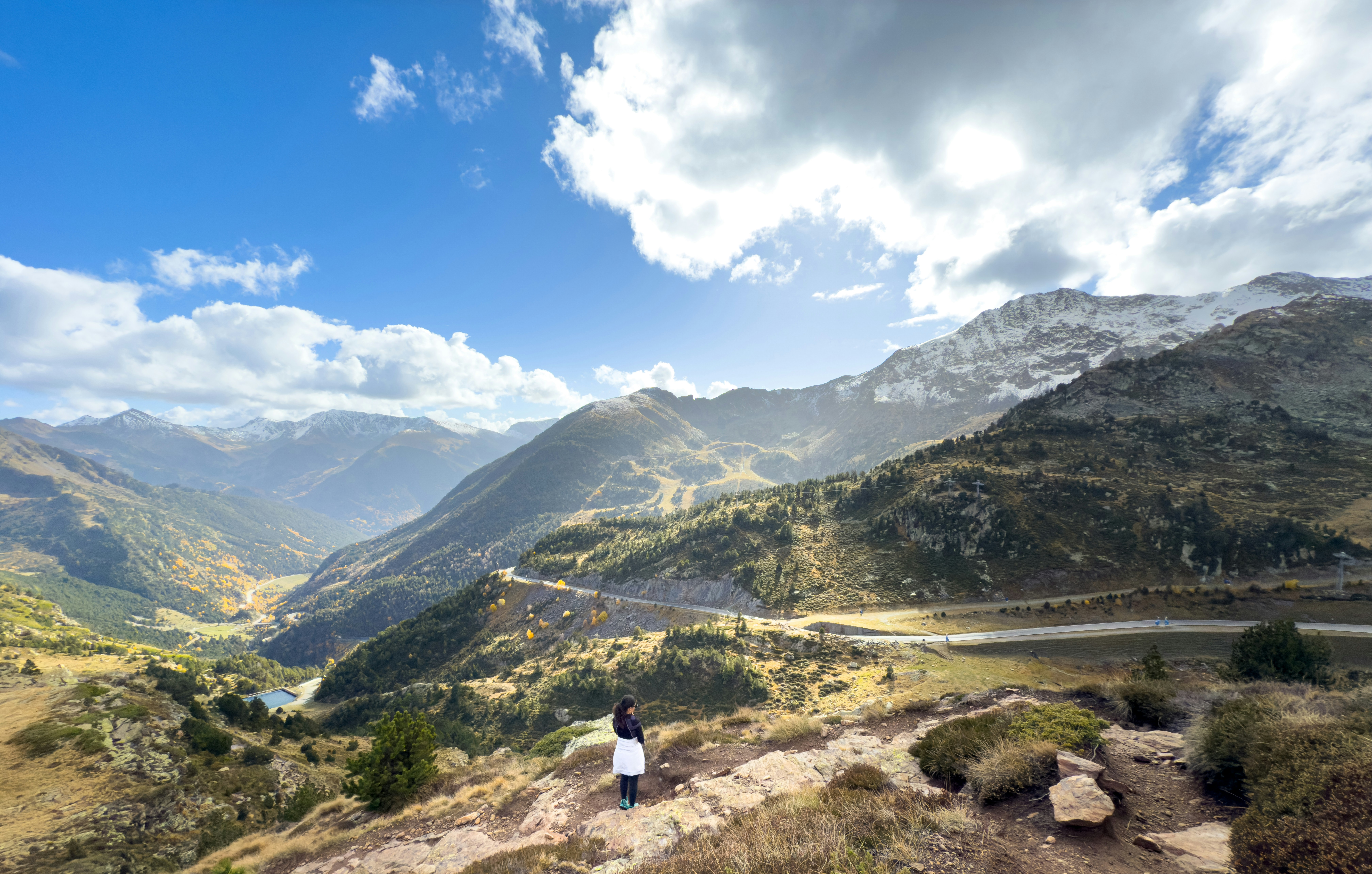 A person standing on top of a mountain overlooking a valley photo ...