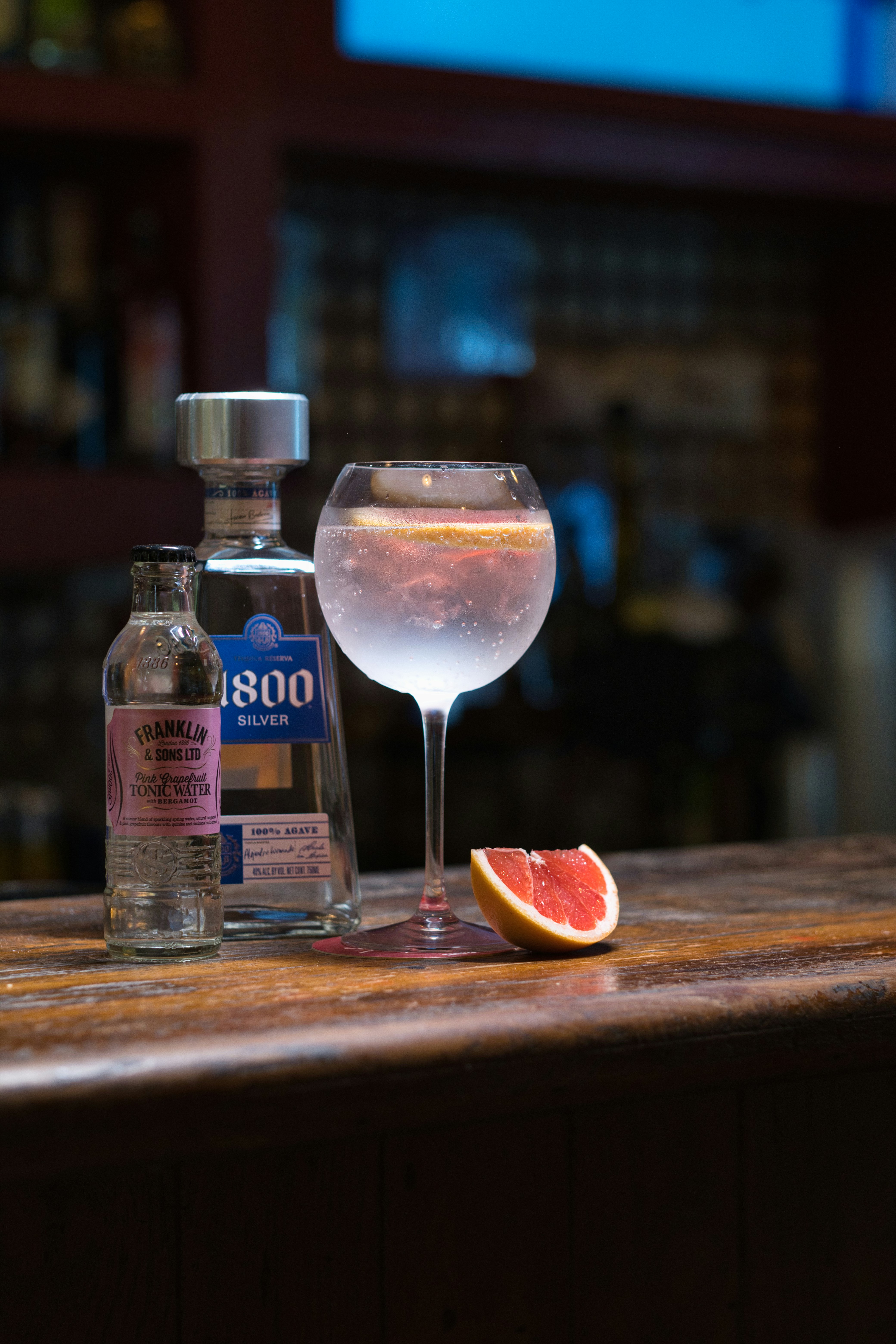 A bottle of booze next to a wine glass and a grapefruit photo – Free ...