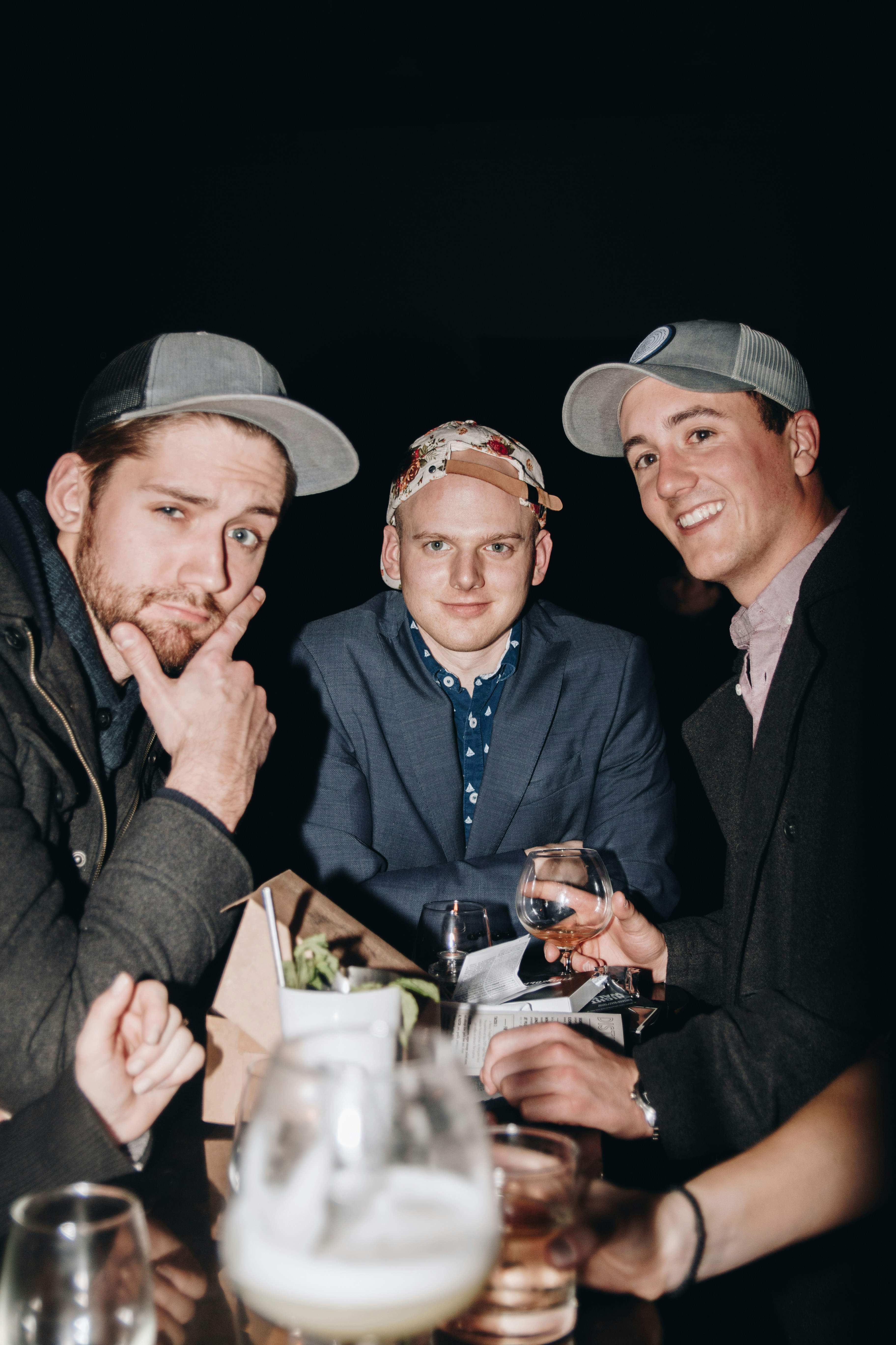 A group of men sitting at a table together photo – Free Portrait Image ...