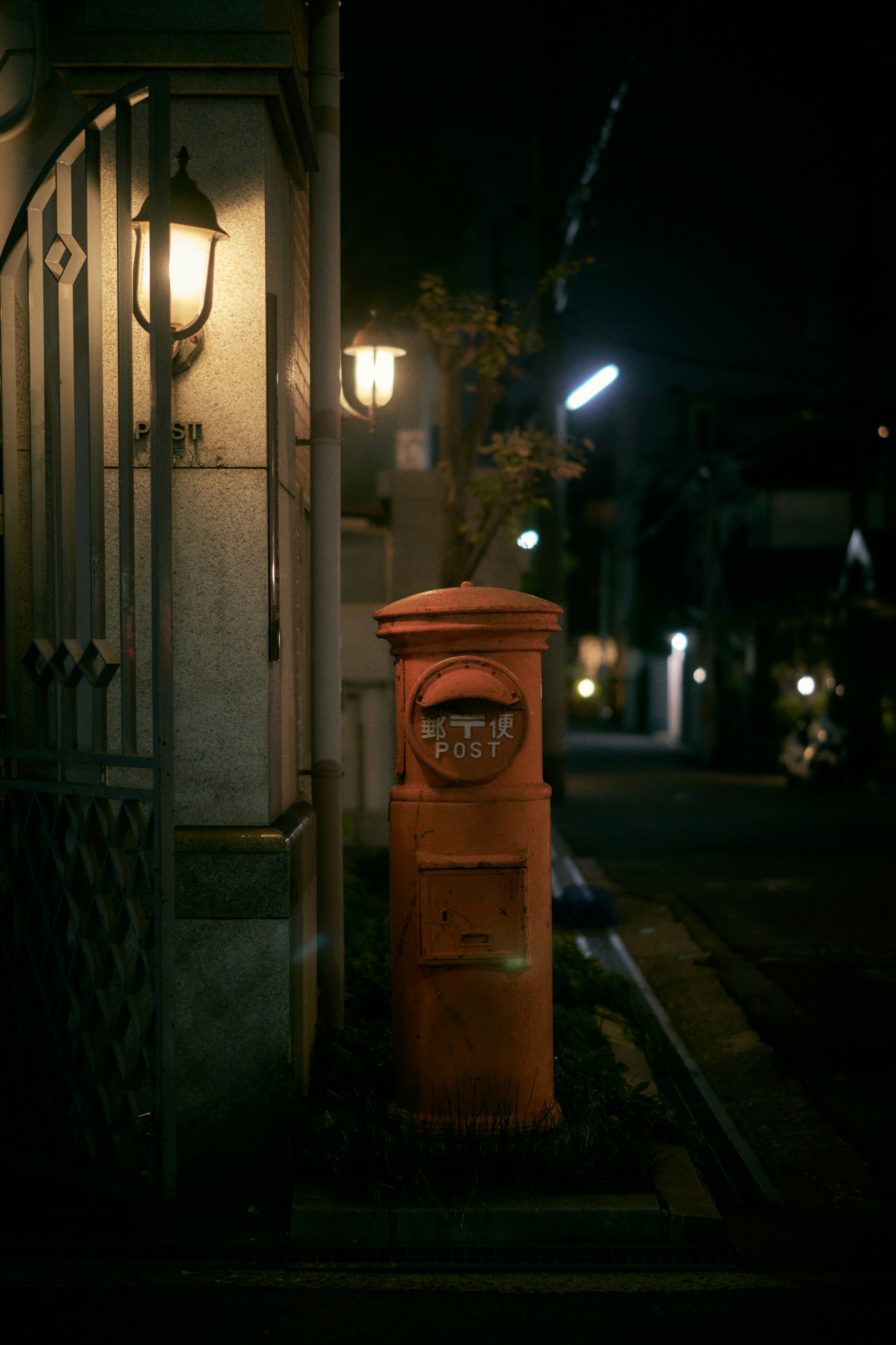 A red post box sitting on the side of a street photo – Free Osaka Image ...