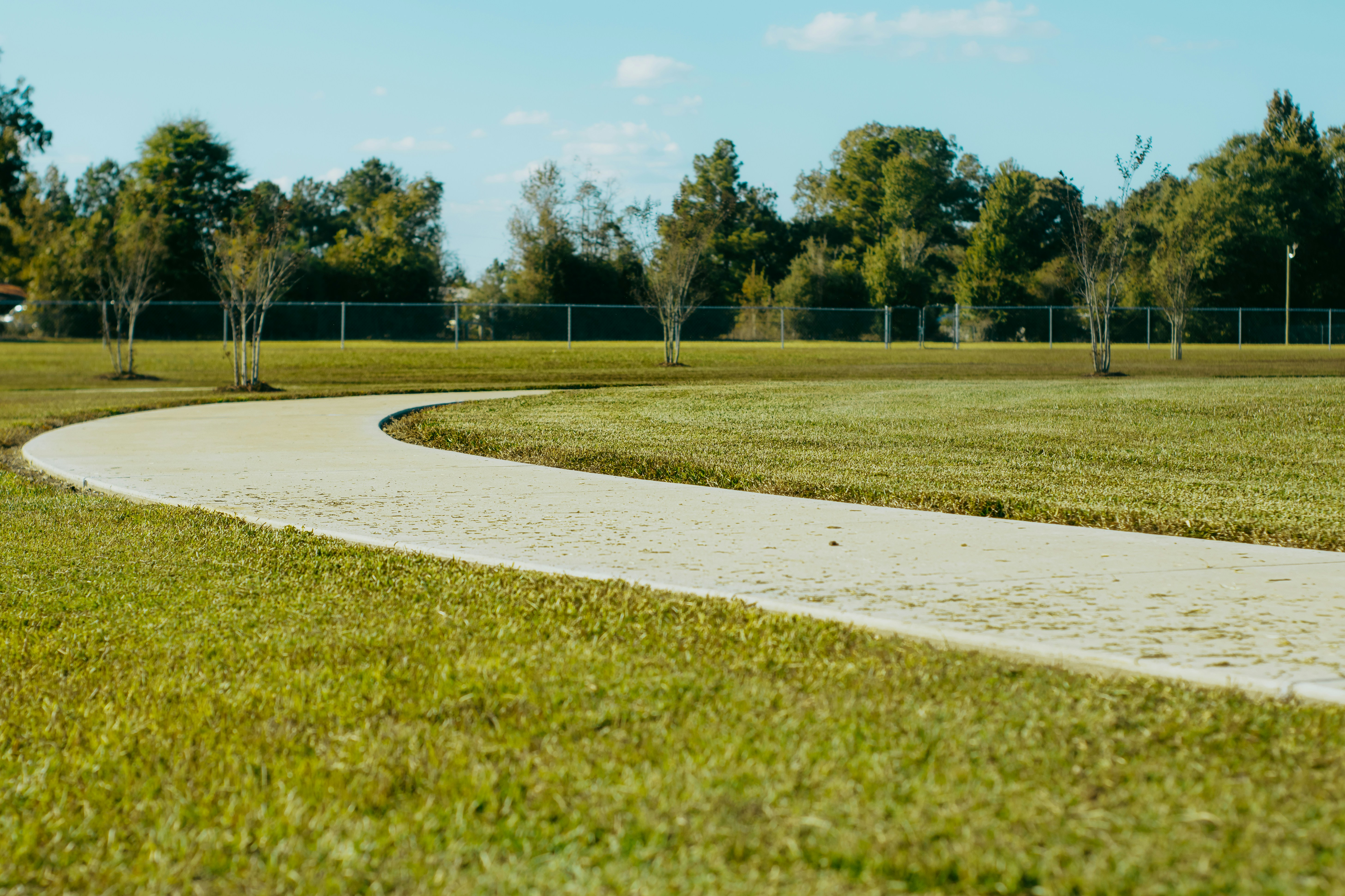 A path in the grass leading to a baseball field