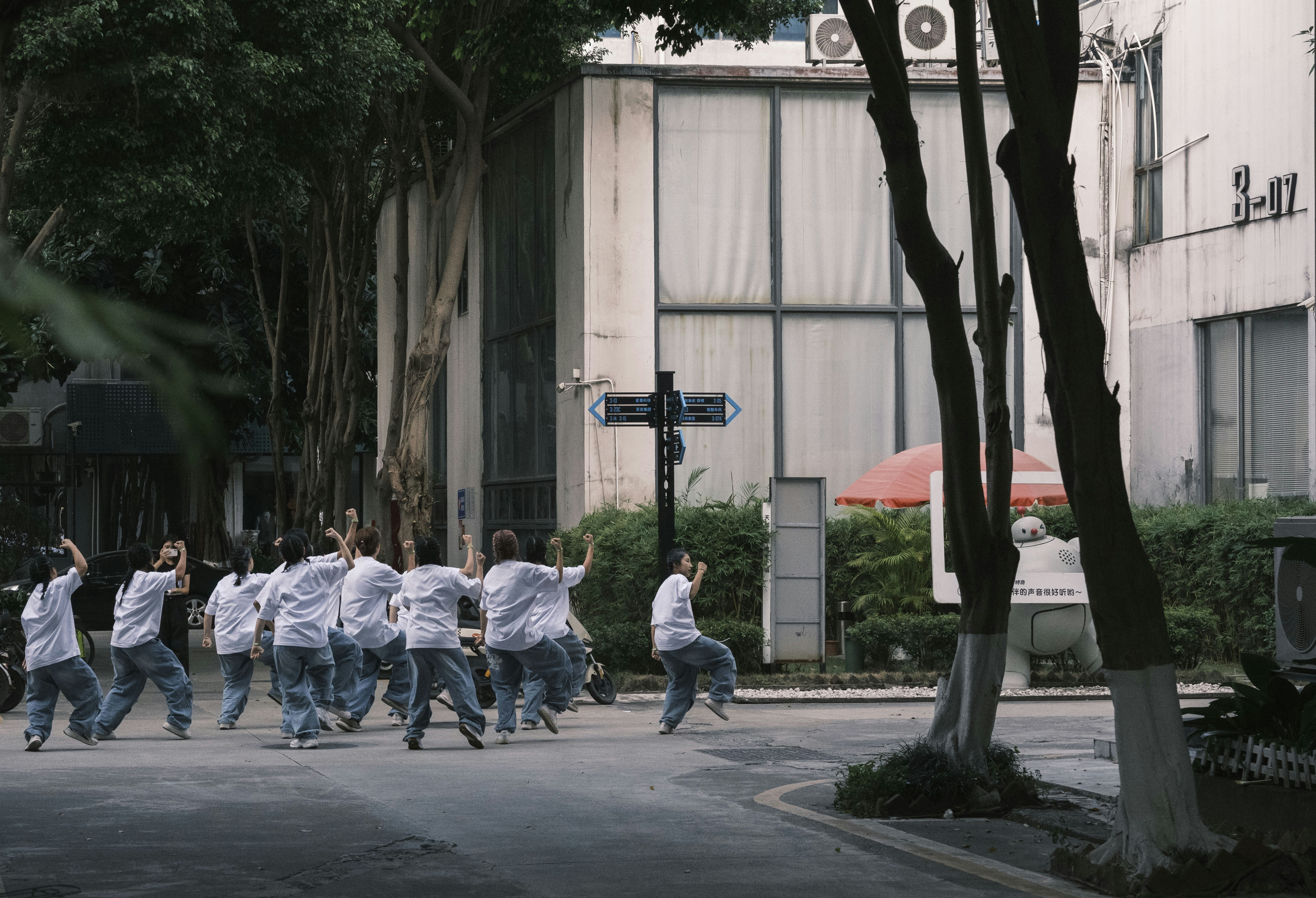 Quiet Procession of White-Topped Figures Through a Sleepy City Block