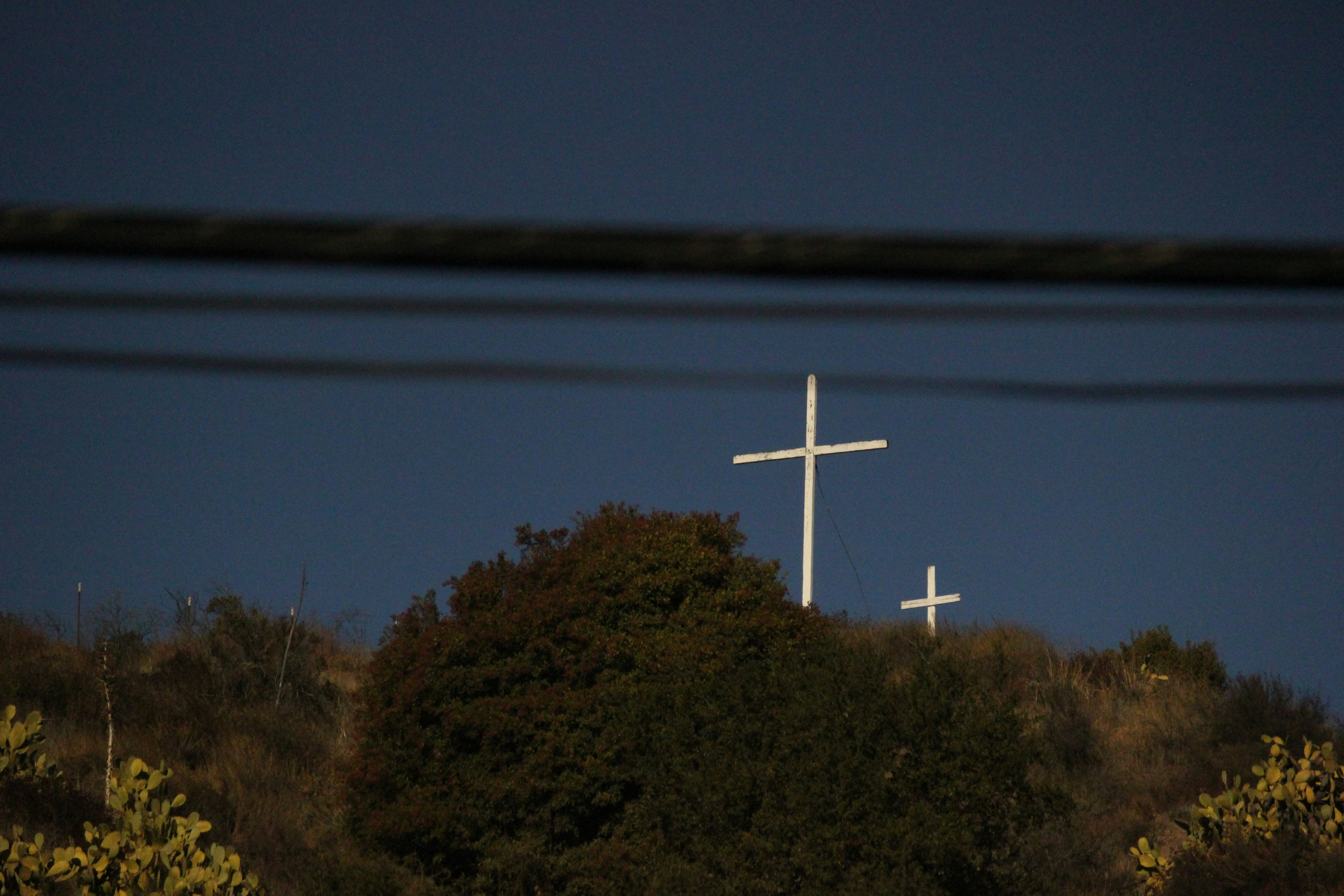 Twin Crosses Standing Watch Over a Dusk-Hushed Hill