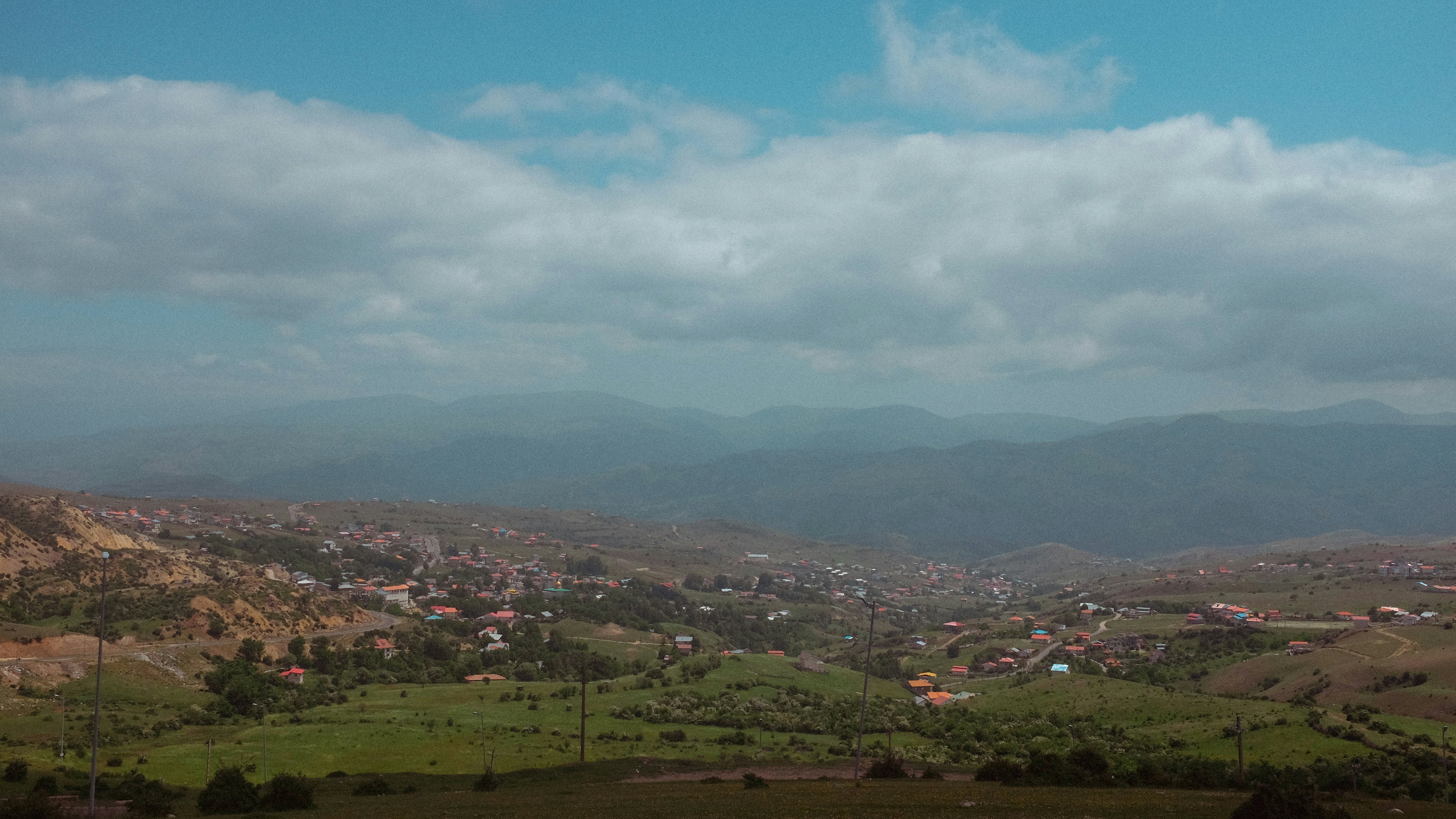 A view of a valley and a town in the distance photo – Free Deylaman ...