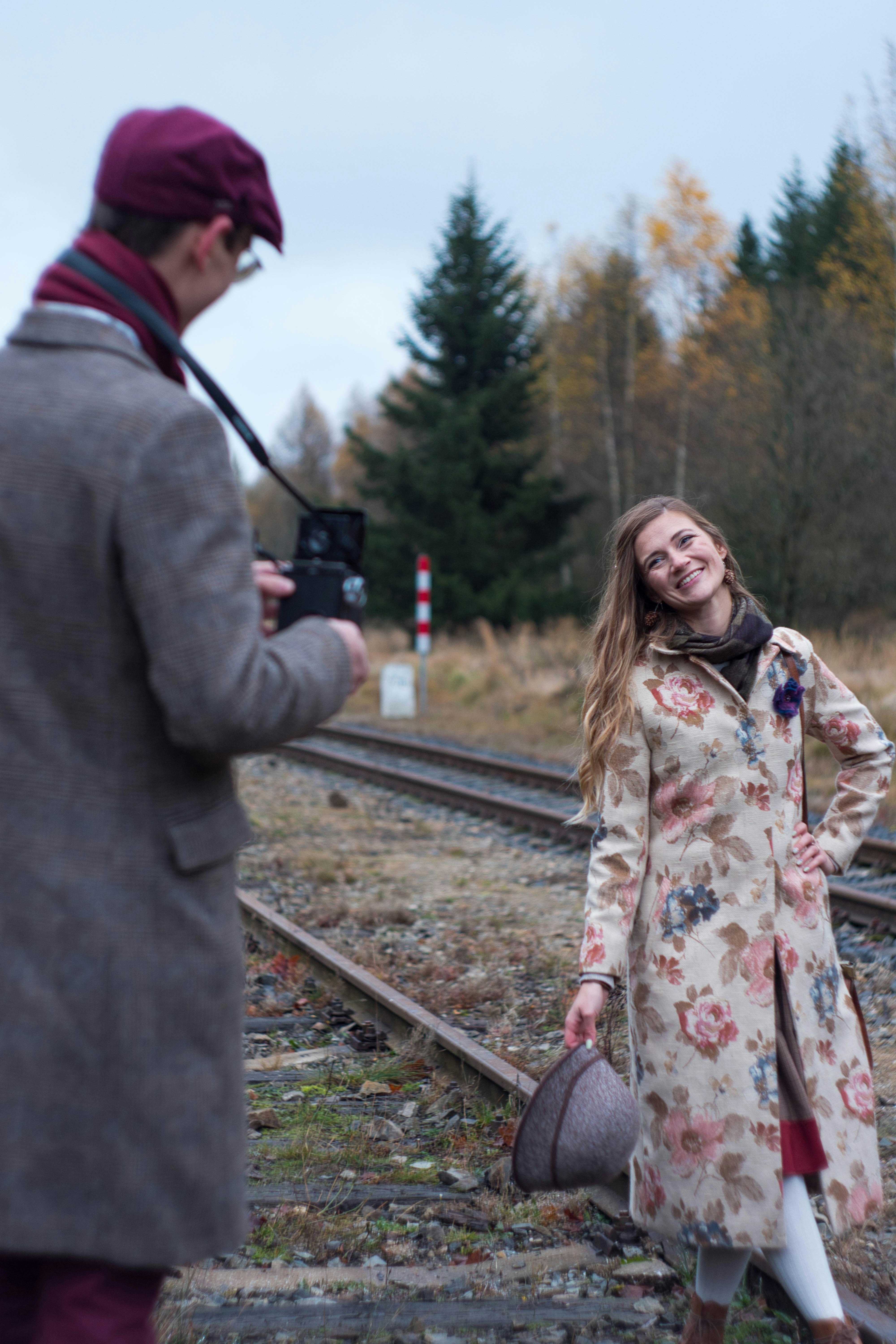 Floral Echoes on the Rails: A candid moment beside autumn tracks