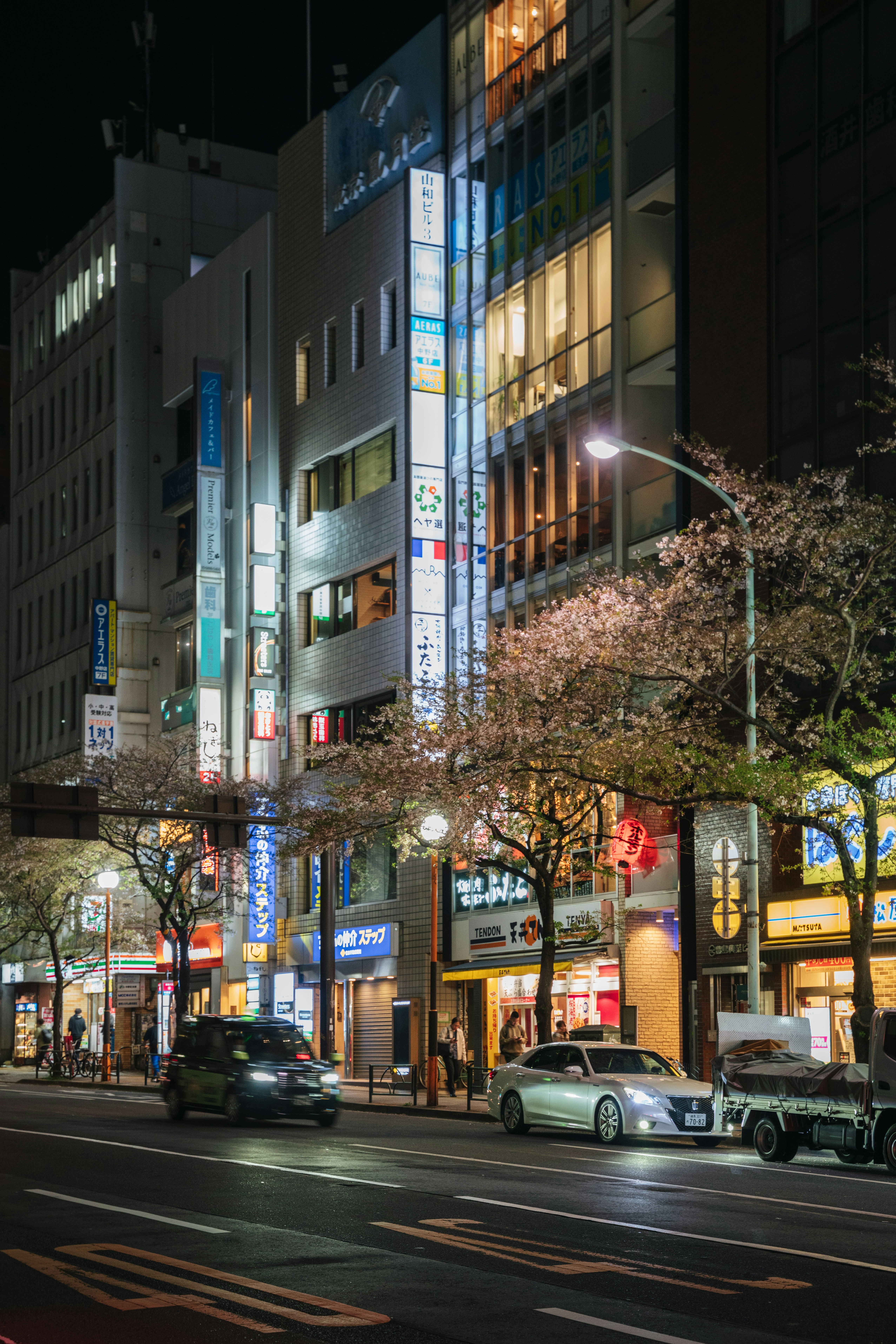 A city street filled with lots of tall buildings