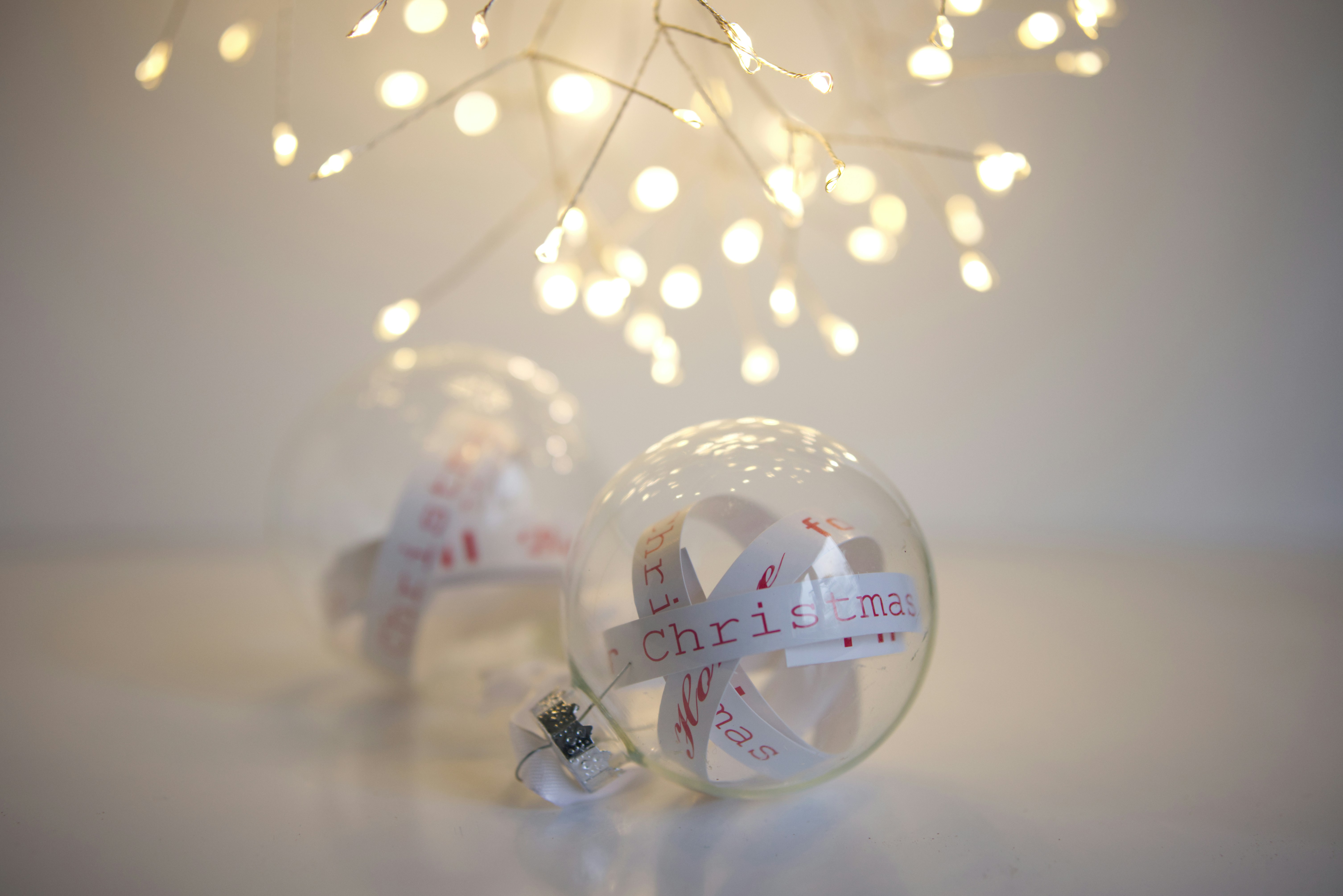 Ribboned Glass Orbs Under a Soft Christmas Glow