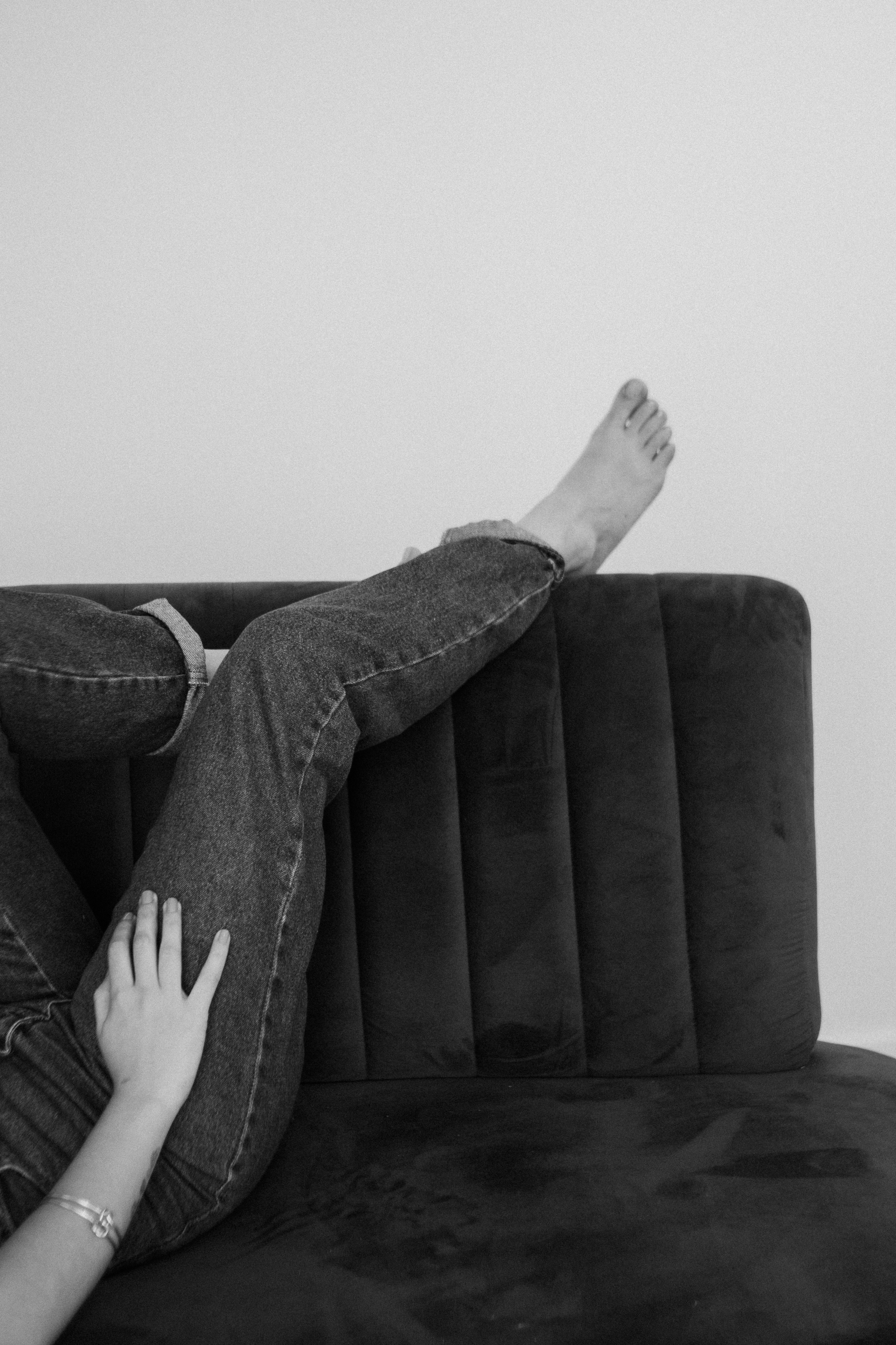 A person laying on a couch with their feet up photo – Free Human Image ...