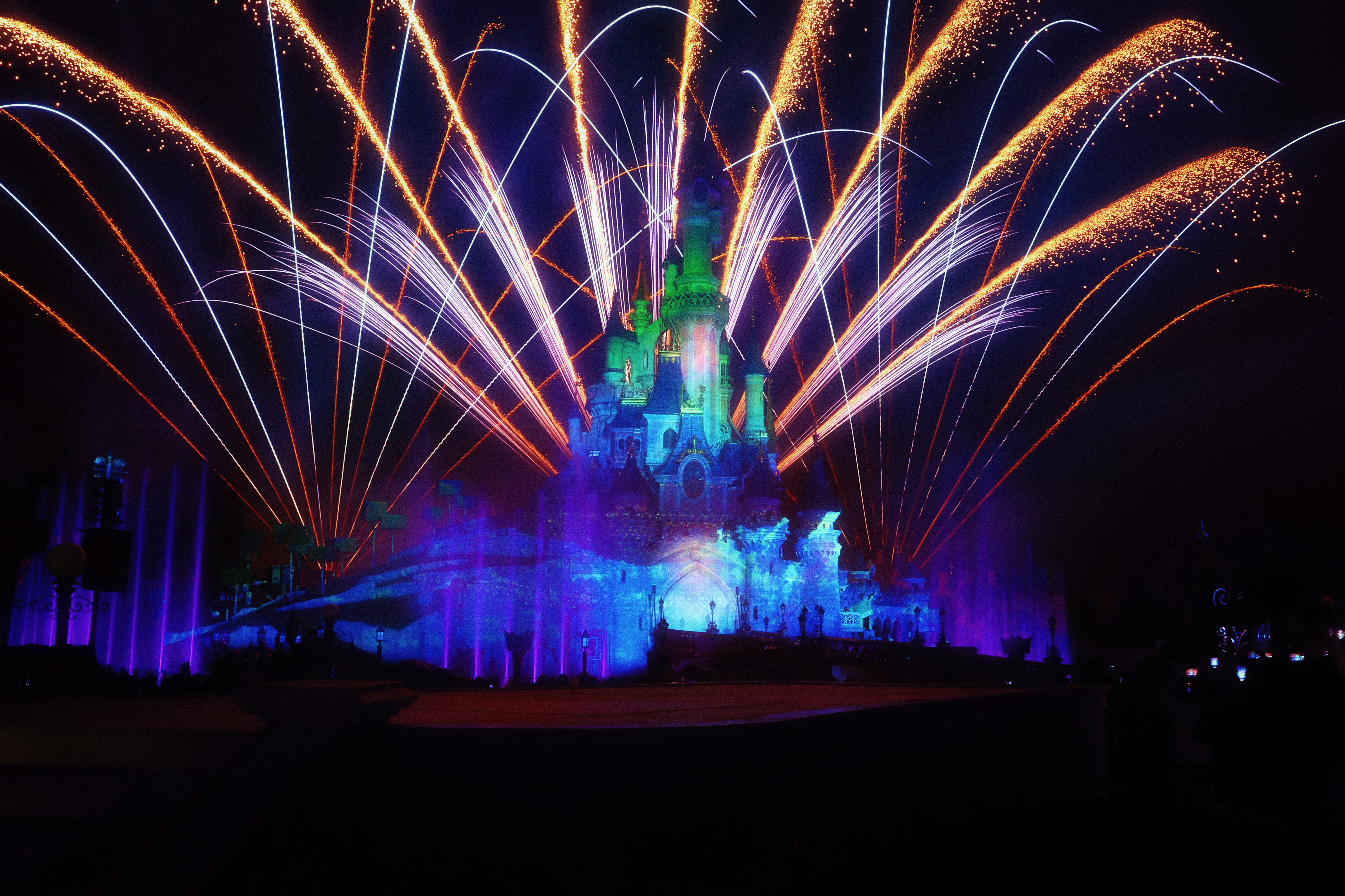Midnight Citadel: Blue-lit Castle Amid Firework Arches