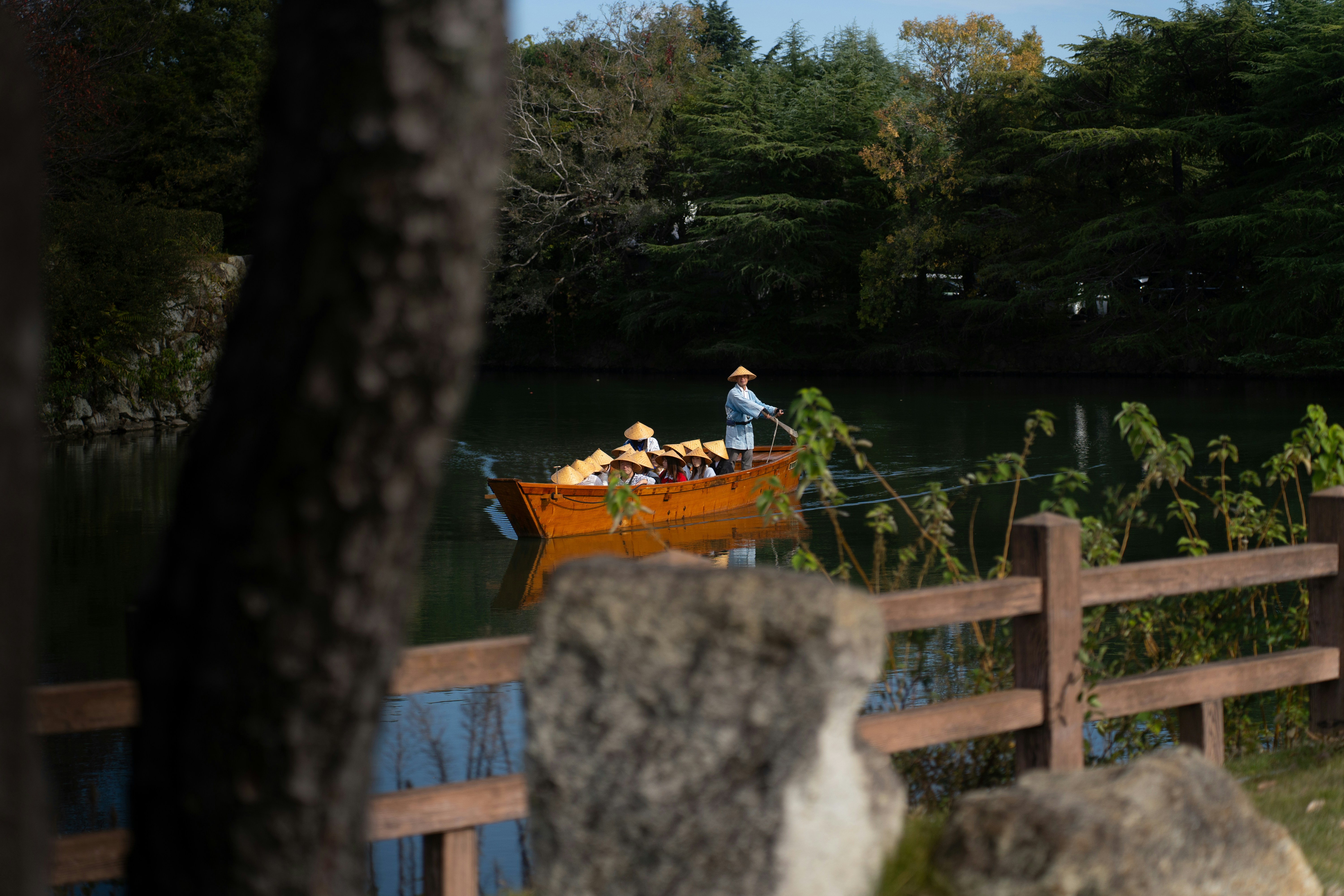 Conical-Hat Fishermen Drift Across a Quiet Lake