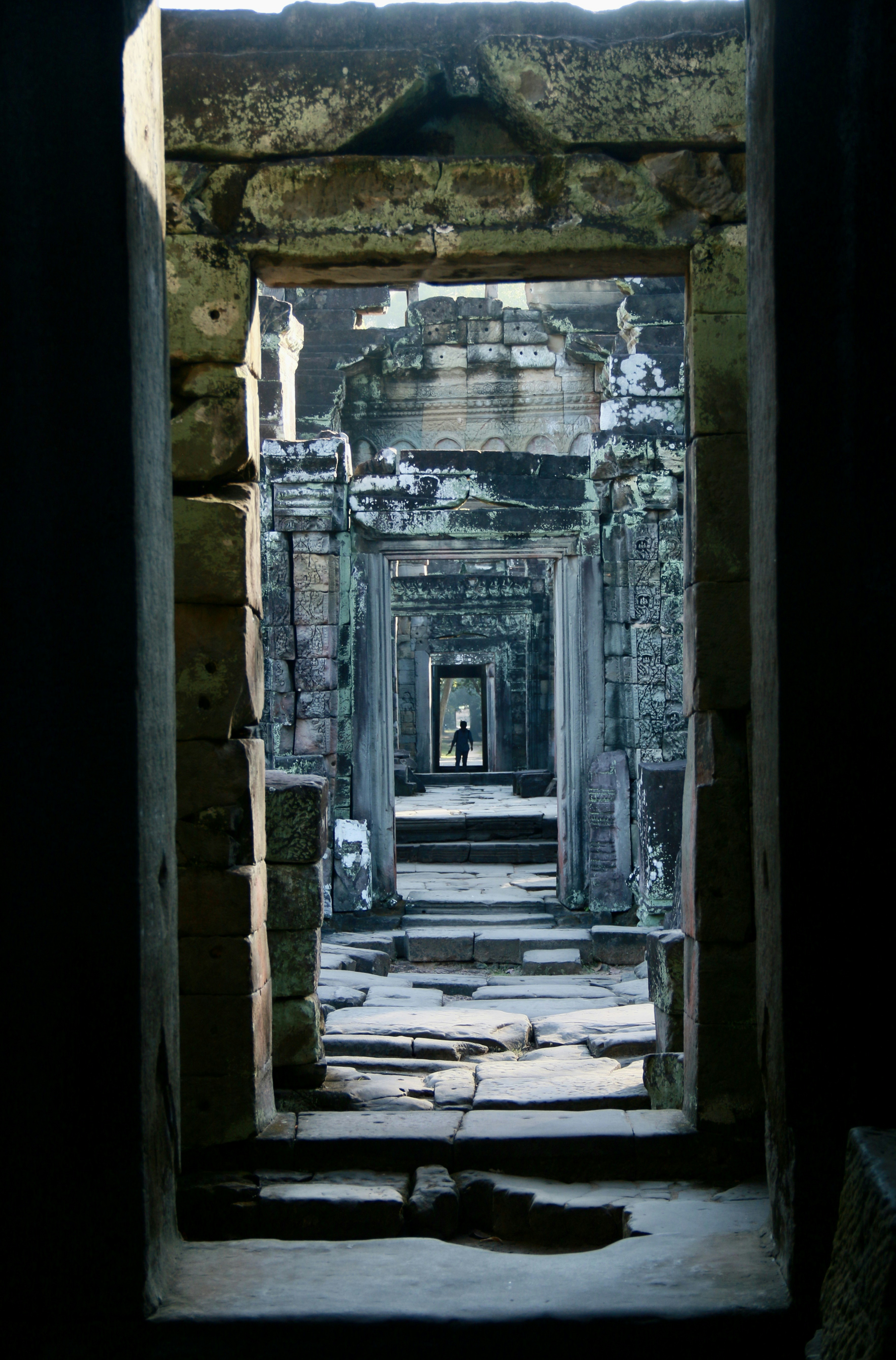 Echoes Through Stone Portals: A Lone Figure Anchors the Endless Corridor
