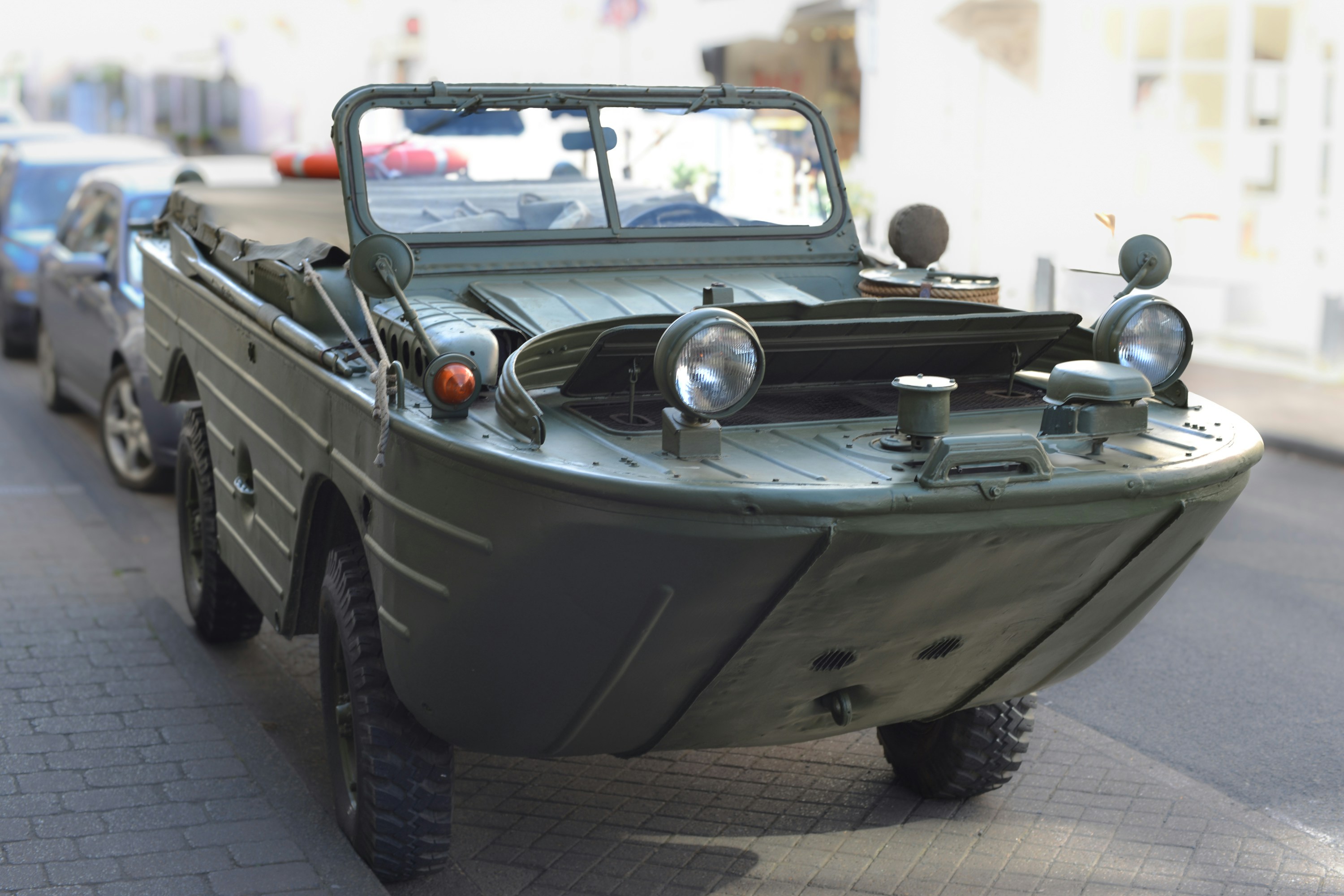 A military vehicle driving down a city street photo – Free Vehicle ...