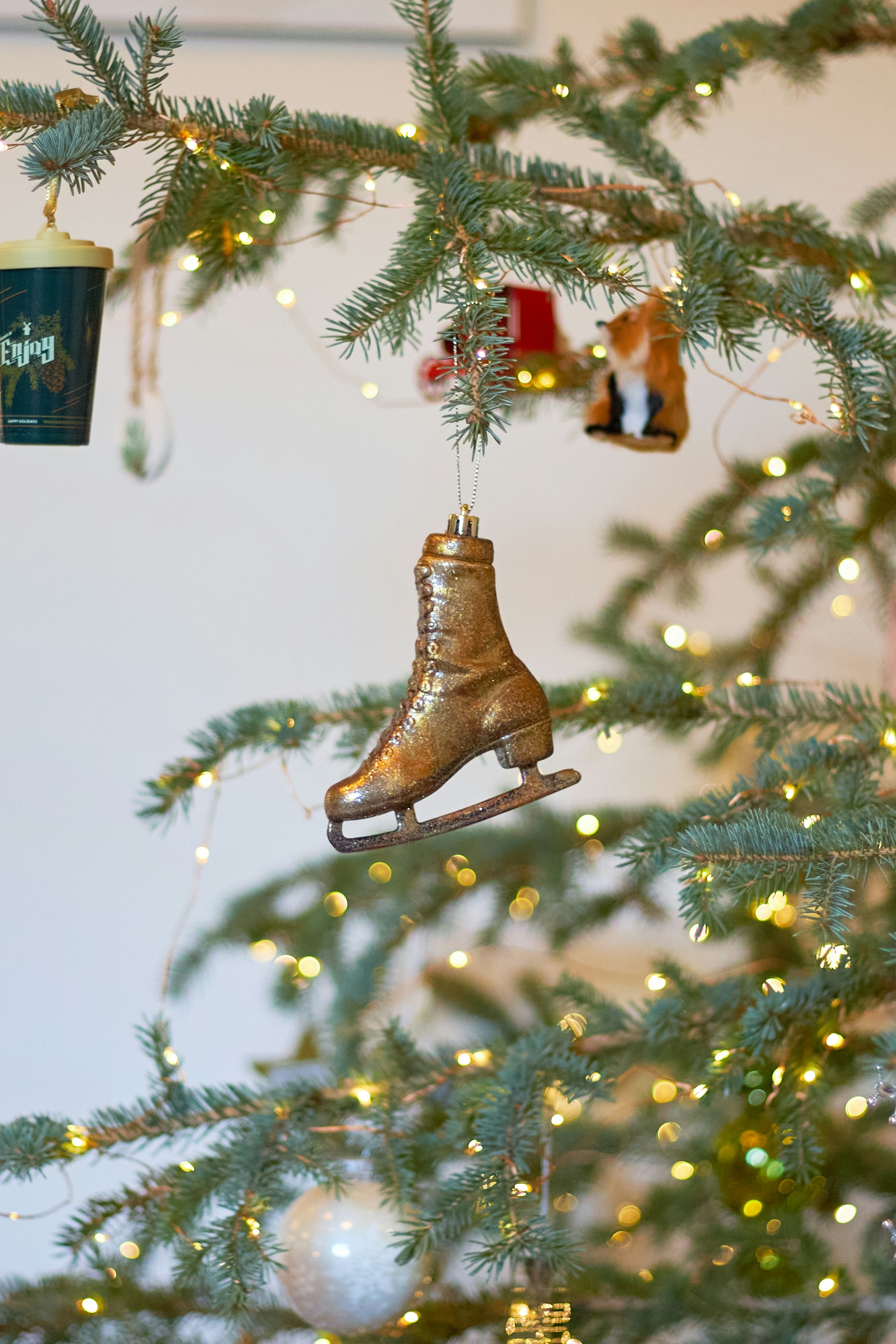 Glittering Gold Ice Skate Ornament Draped in Soft Holiday Glow