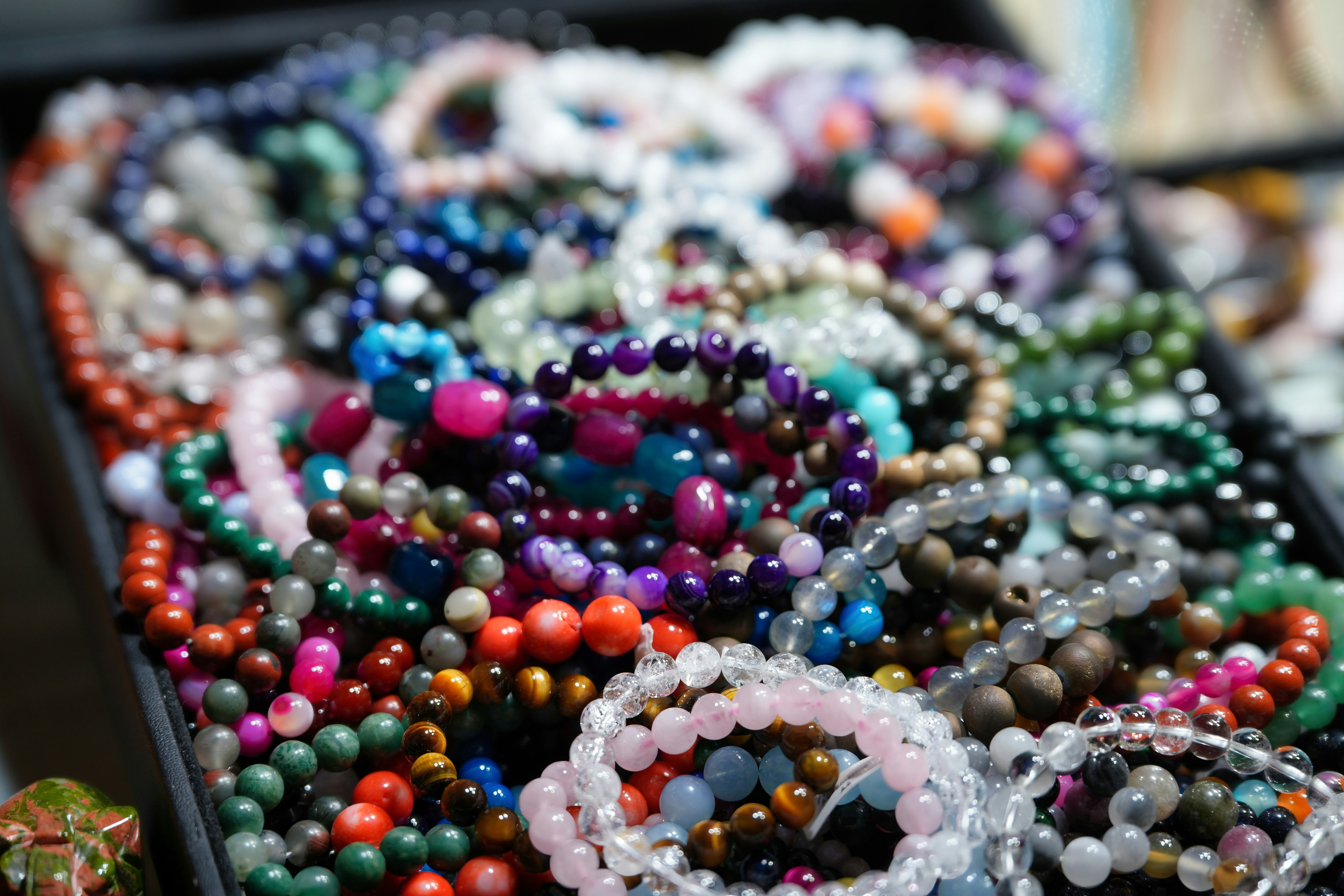 A table topped with lots of beads and bracelets photo – Free Jarmark ...