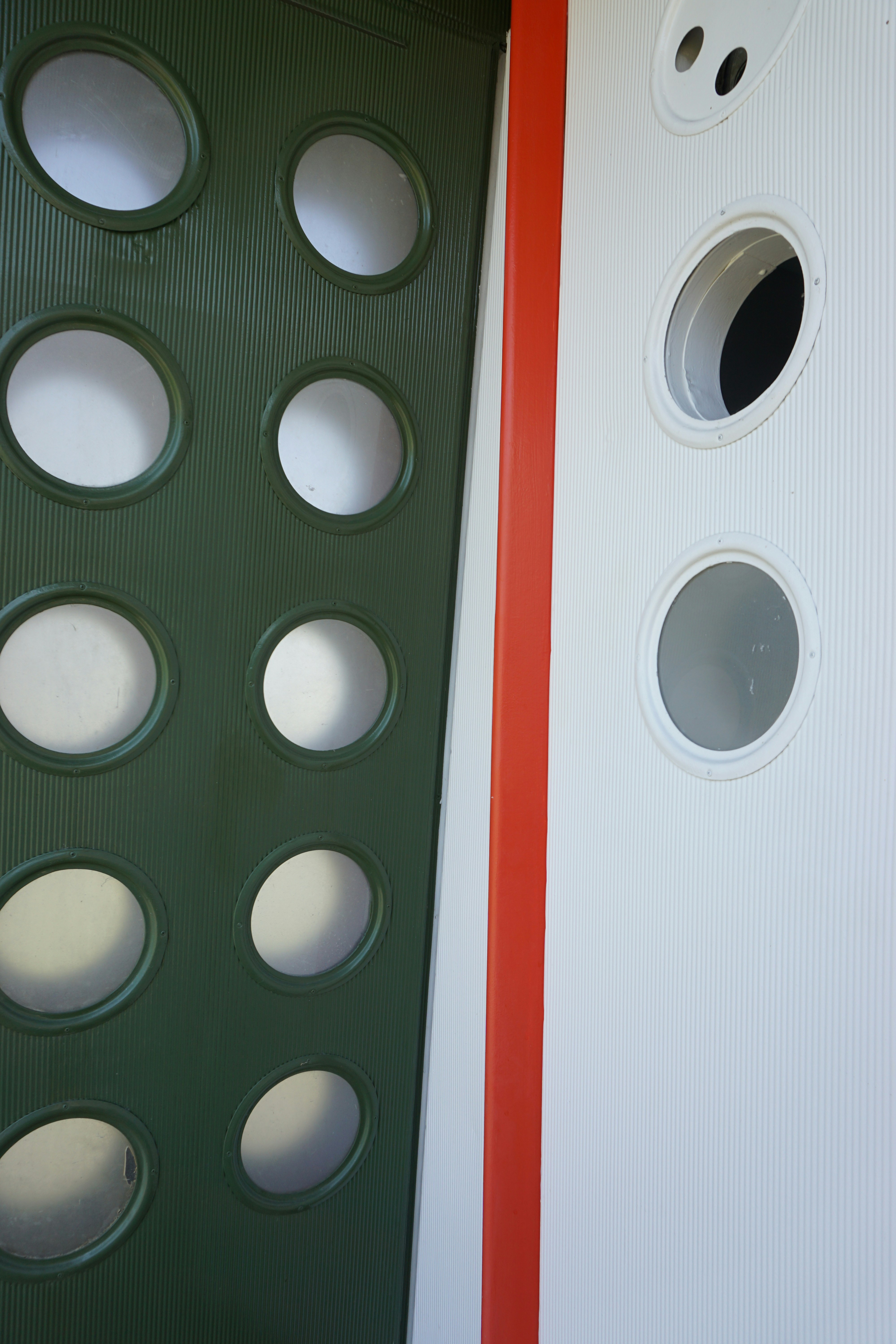 Crimson Divider Between Green Portholes: A Study in Circular Rhythm